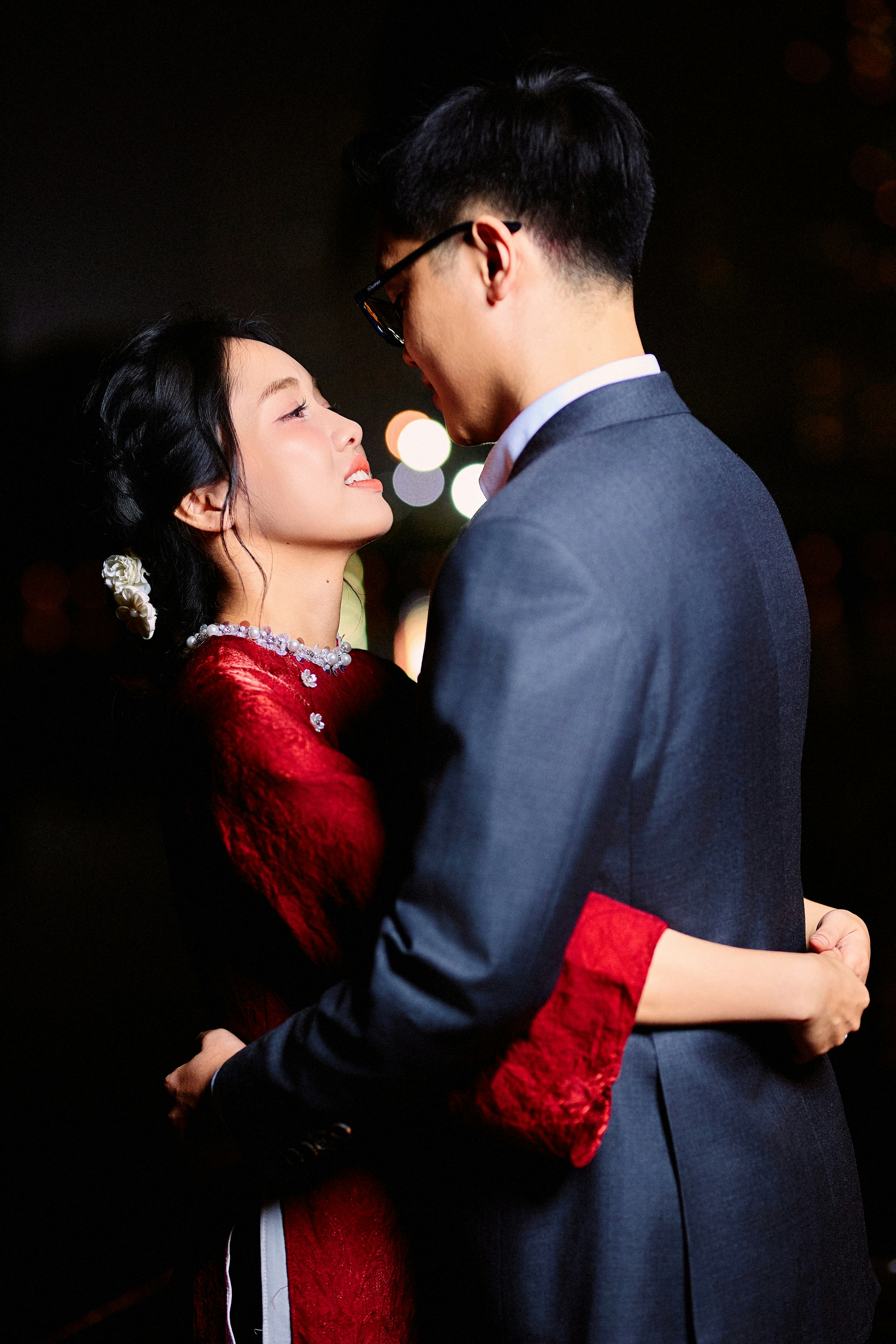 Close embrace under evening lights: a tender duet in velvet and wool