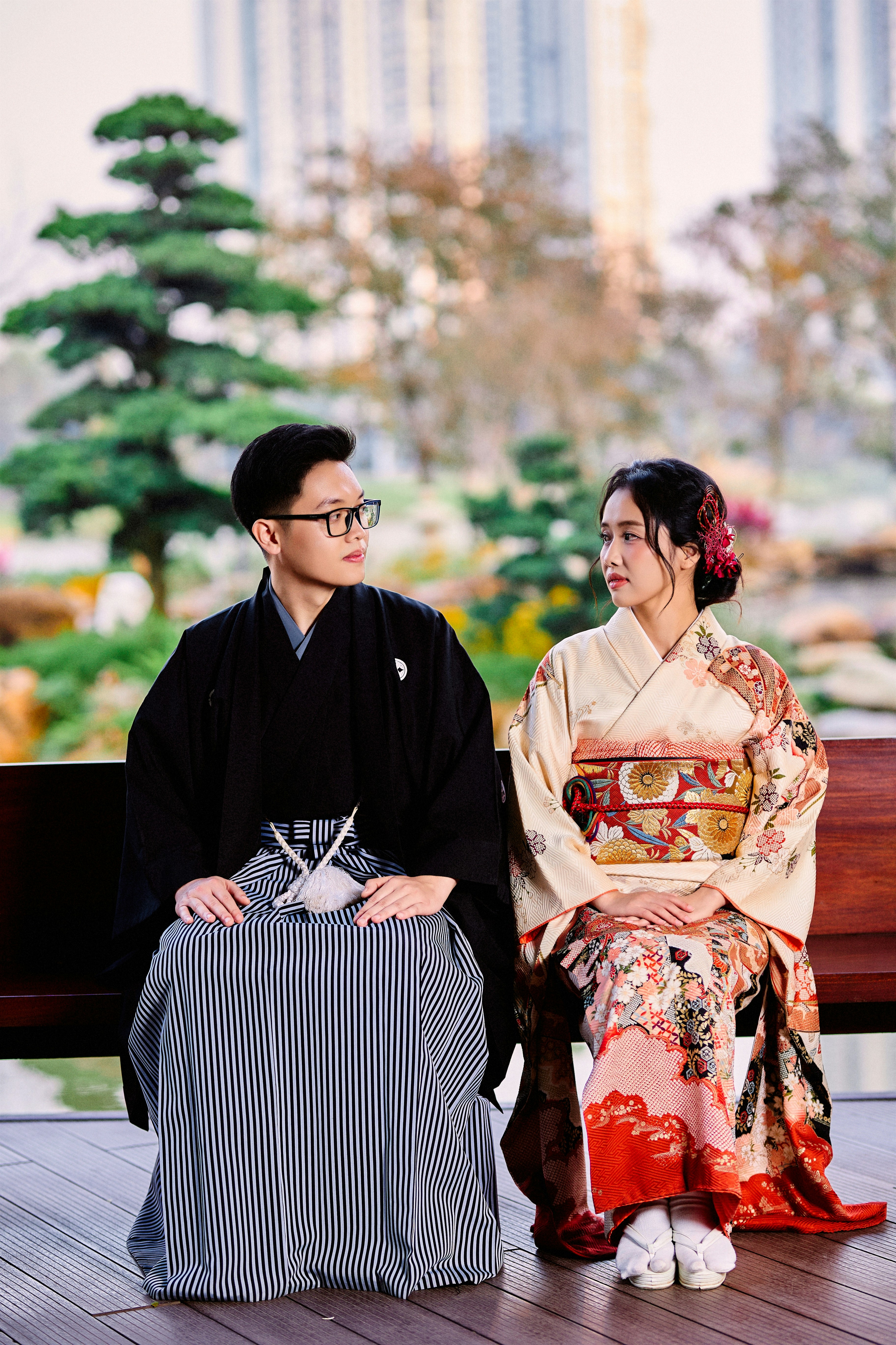 A joyful couple sharing a tender moment, smiling warmly at each other while taking a stroll outdoors. The image radiates genuine happiness, commitment, and the beautiful milestone of a long-lasting relationship.