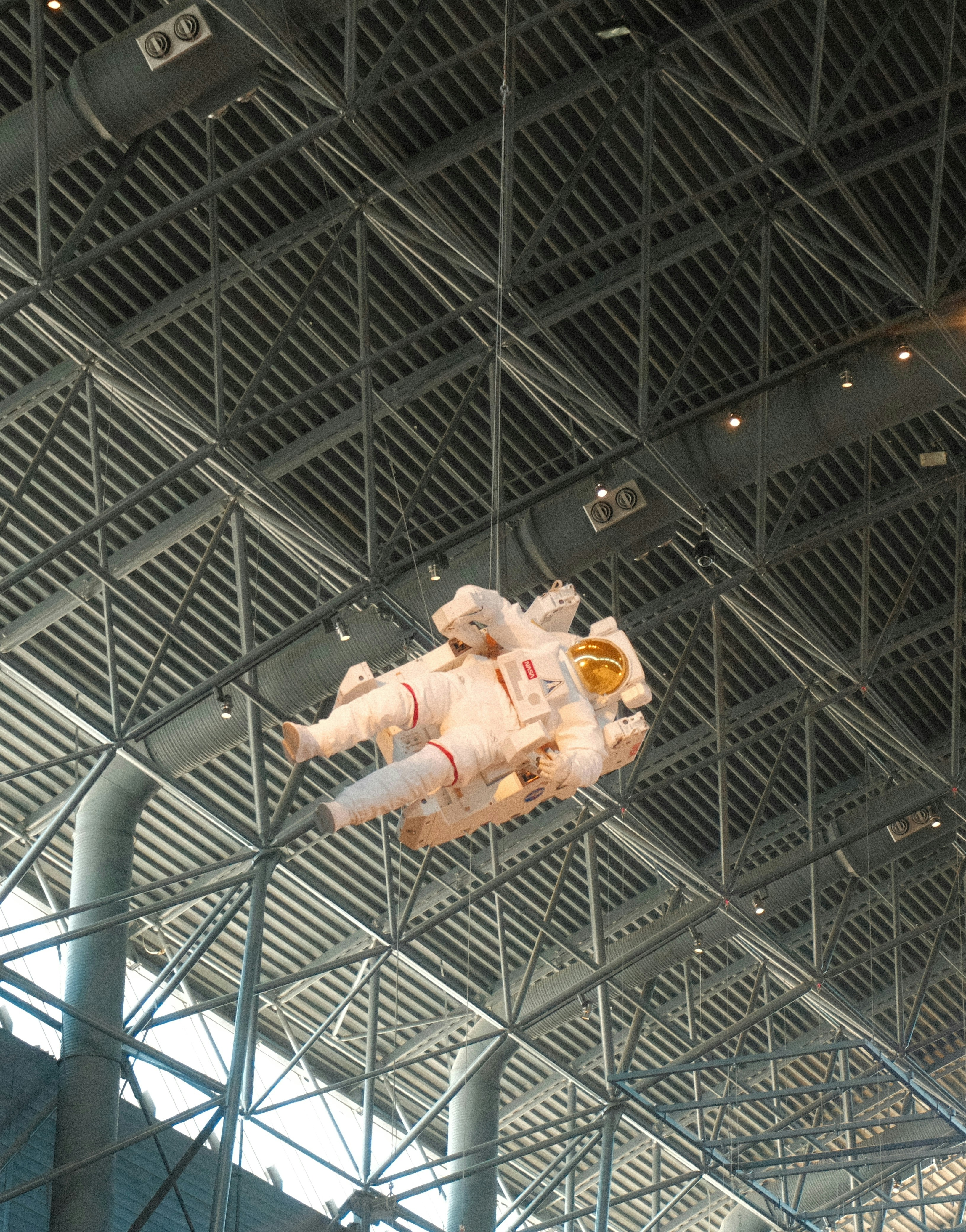 Astronauts in Orbit: Floating Duo Inside a Geometric Hangar