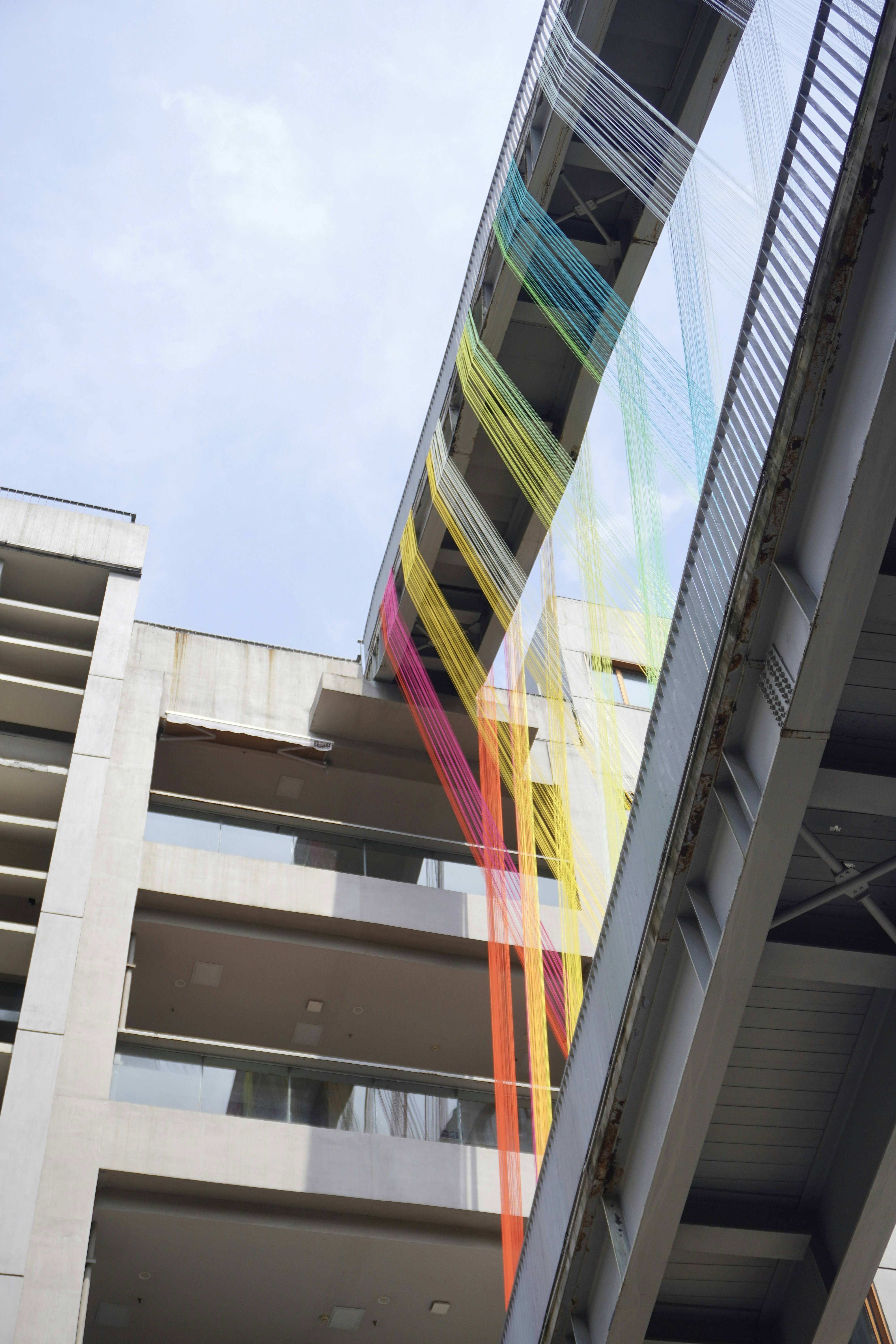 Colorful Ribbon Cascade Across an Industrial Atrium