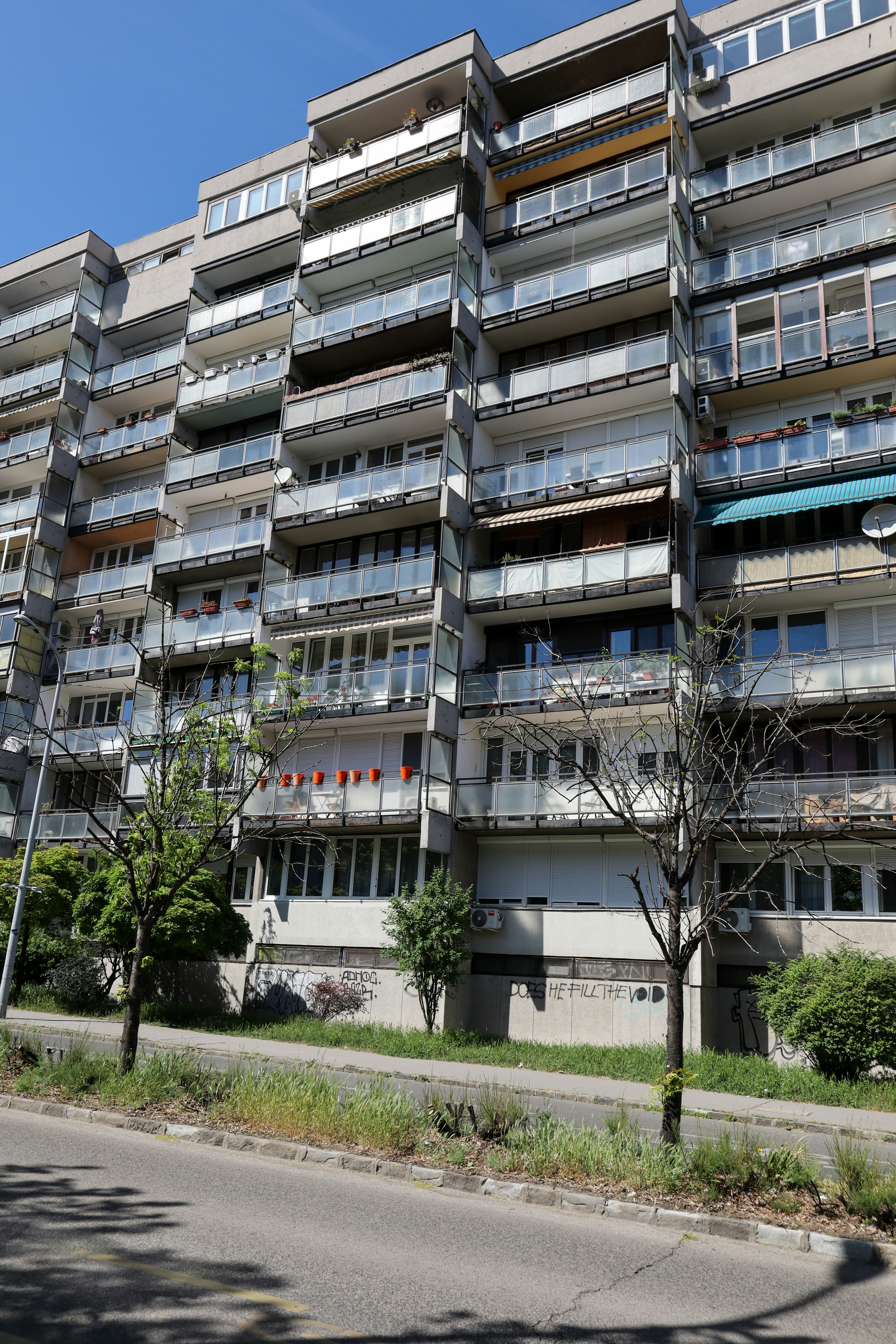 Urban Giants: A Facade of Balconies Under a Clear Sky