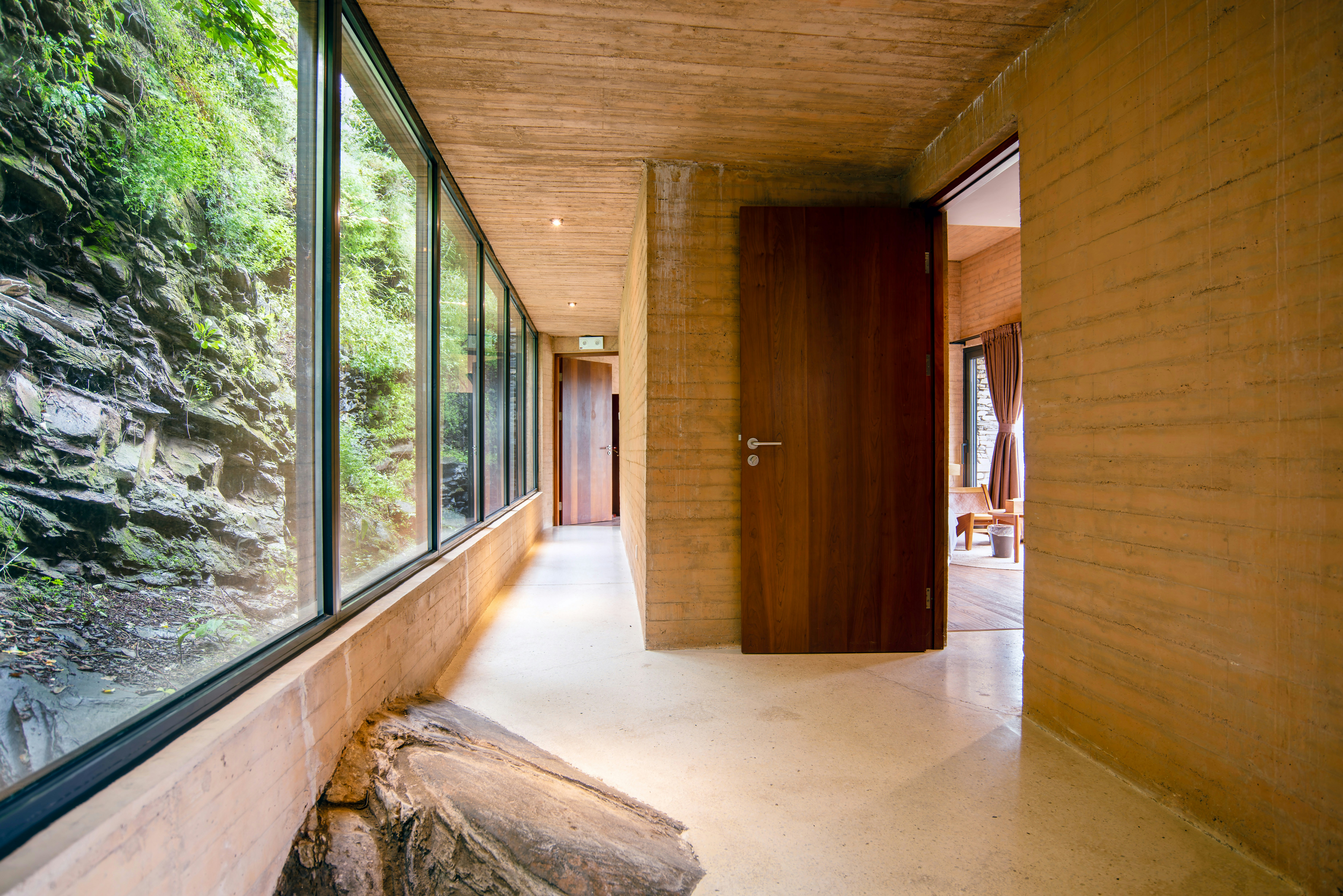 Quiet Corridor to a Glass-Guarded Green Wall