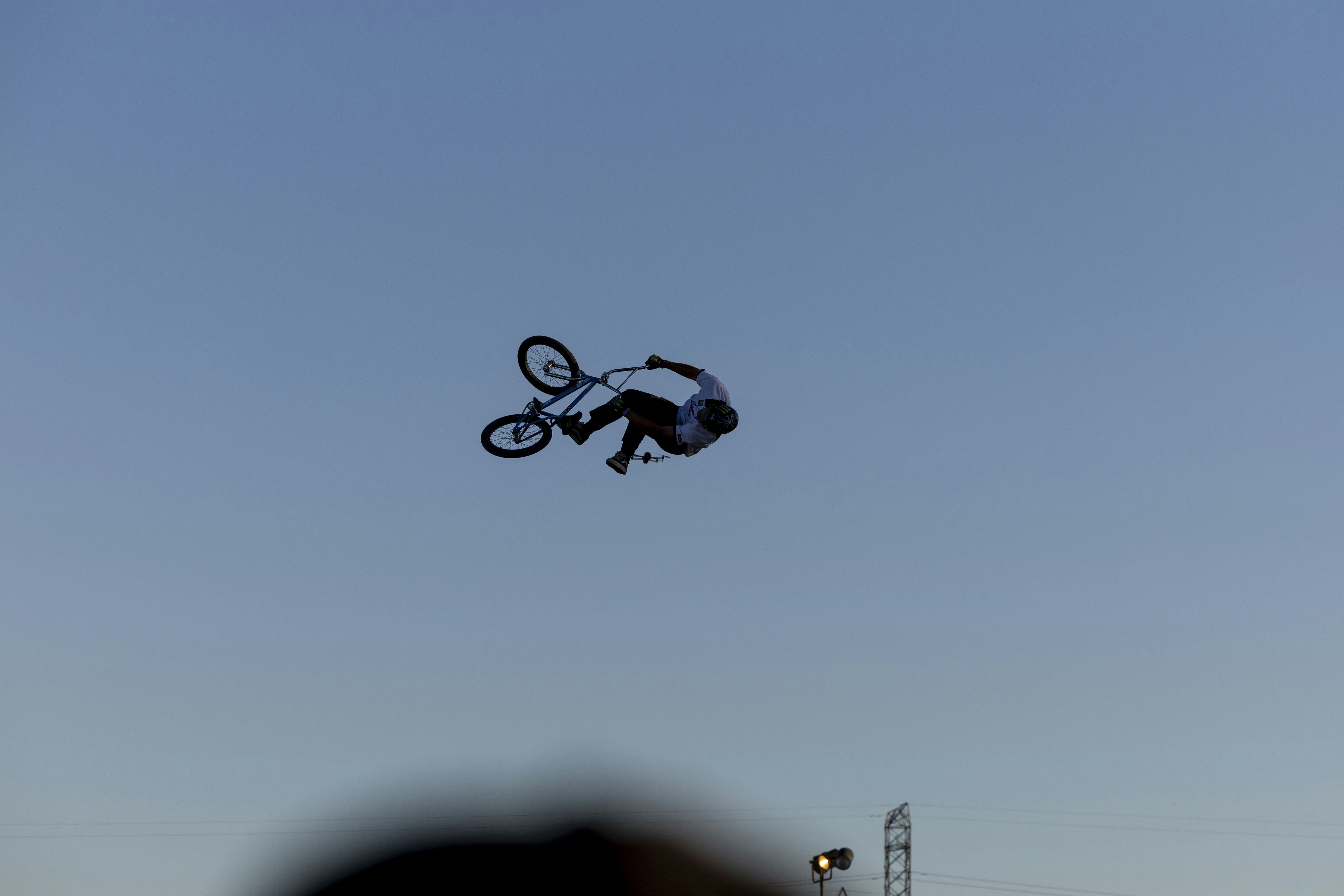 Aerial BMX Leap Under a Clear Blue Sky