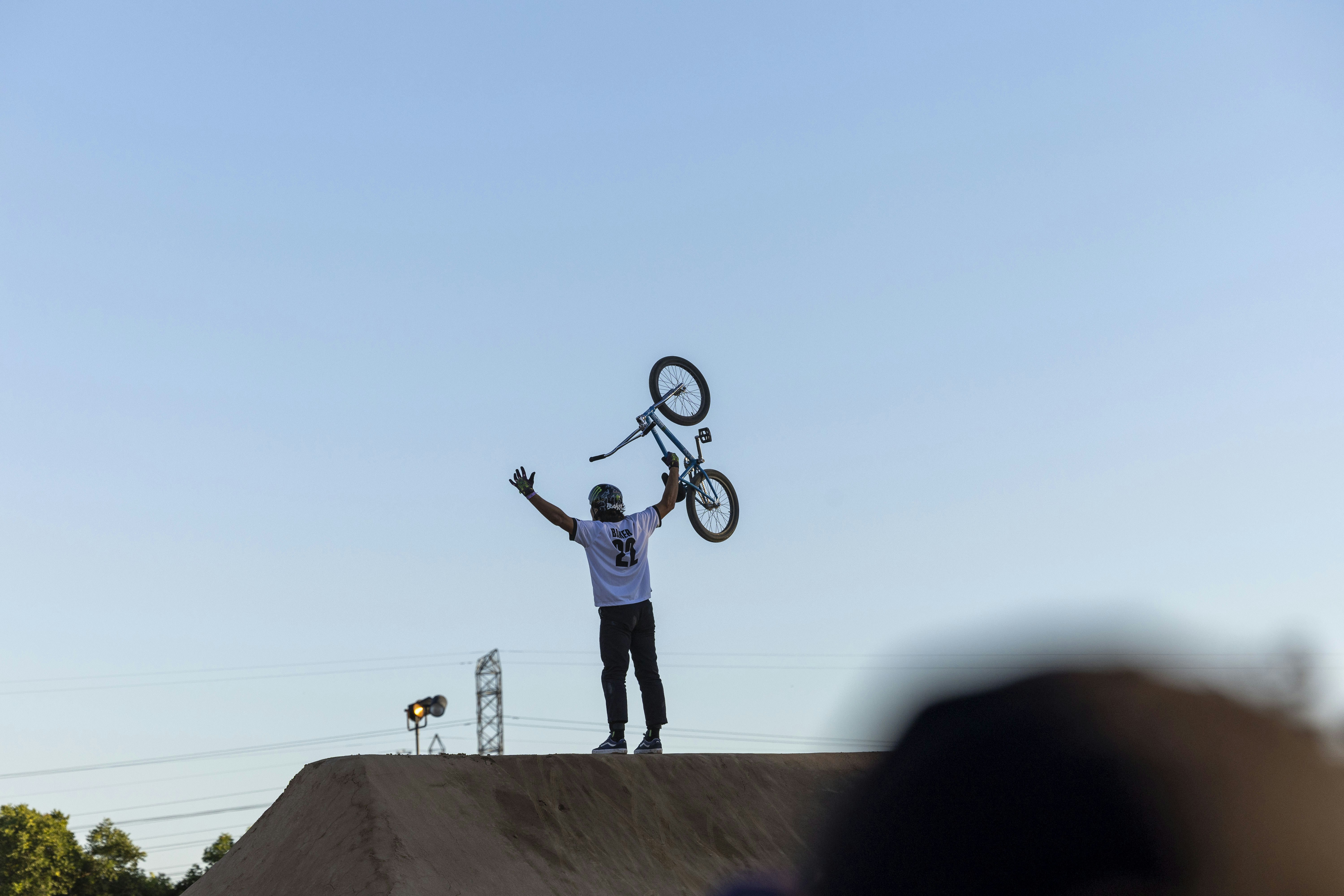 Midair Victory: Rider Raises Triumph Above the Ramp