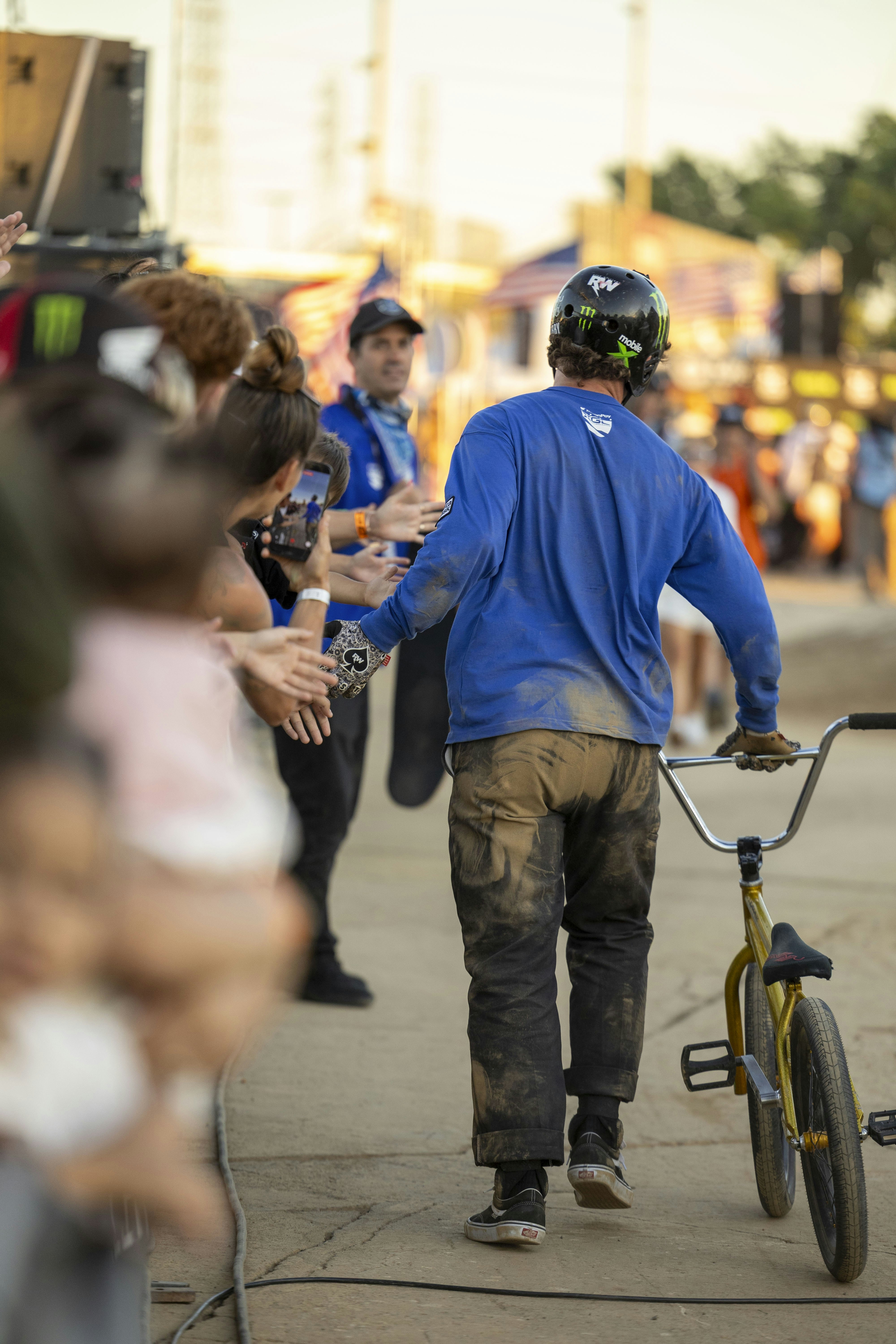 Blue Shirt Sprint: BMX Rider Navigates a Friendly Paradox of Speed and Crowd
