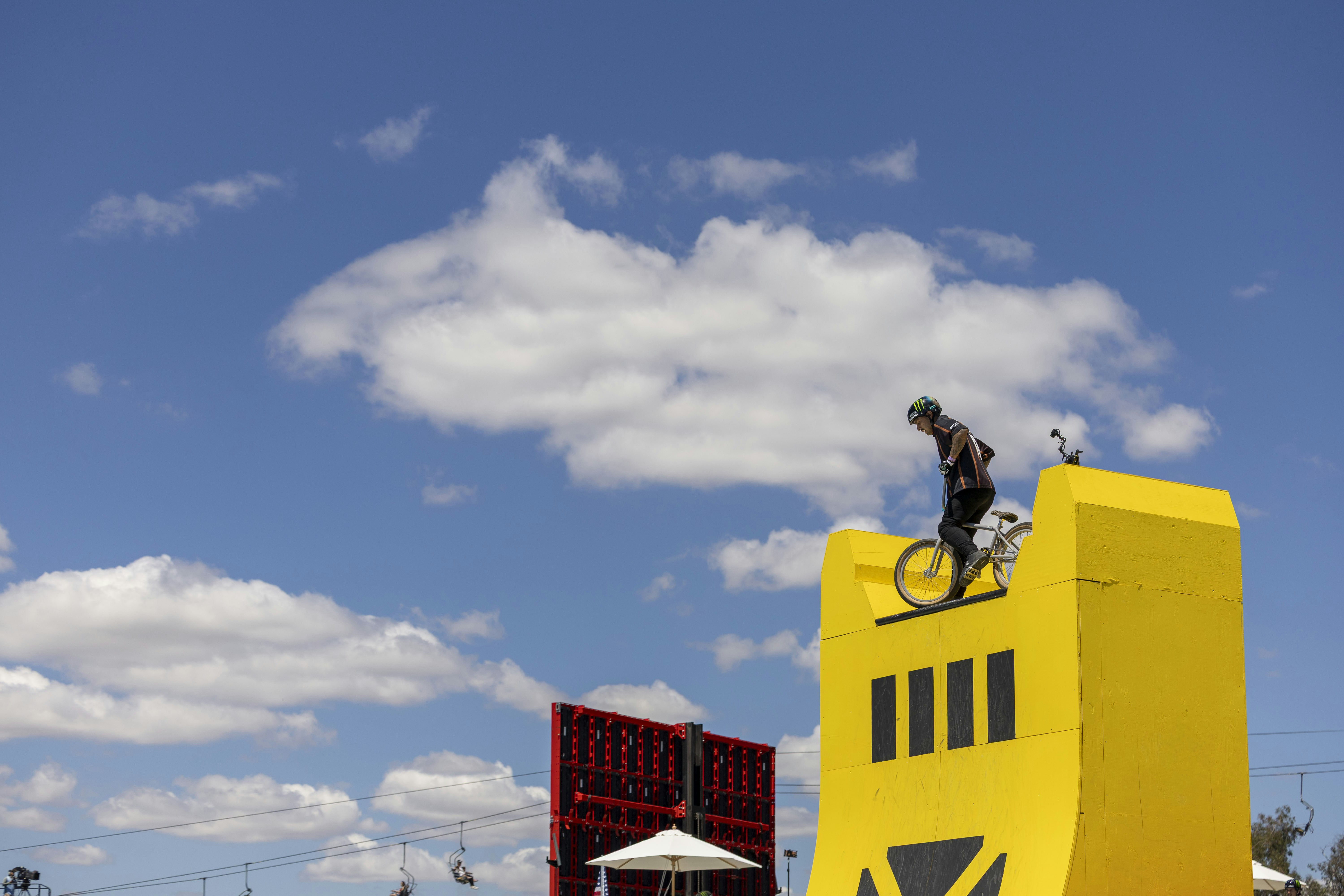 High-Flying Balance: Rider at the Edge of a Bright Yellow Structure