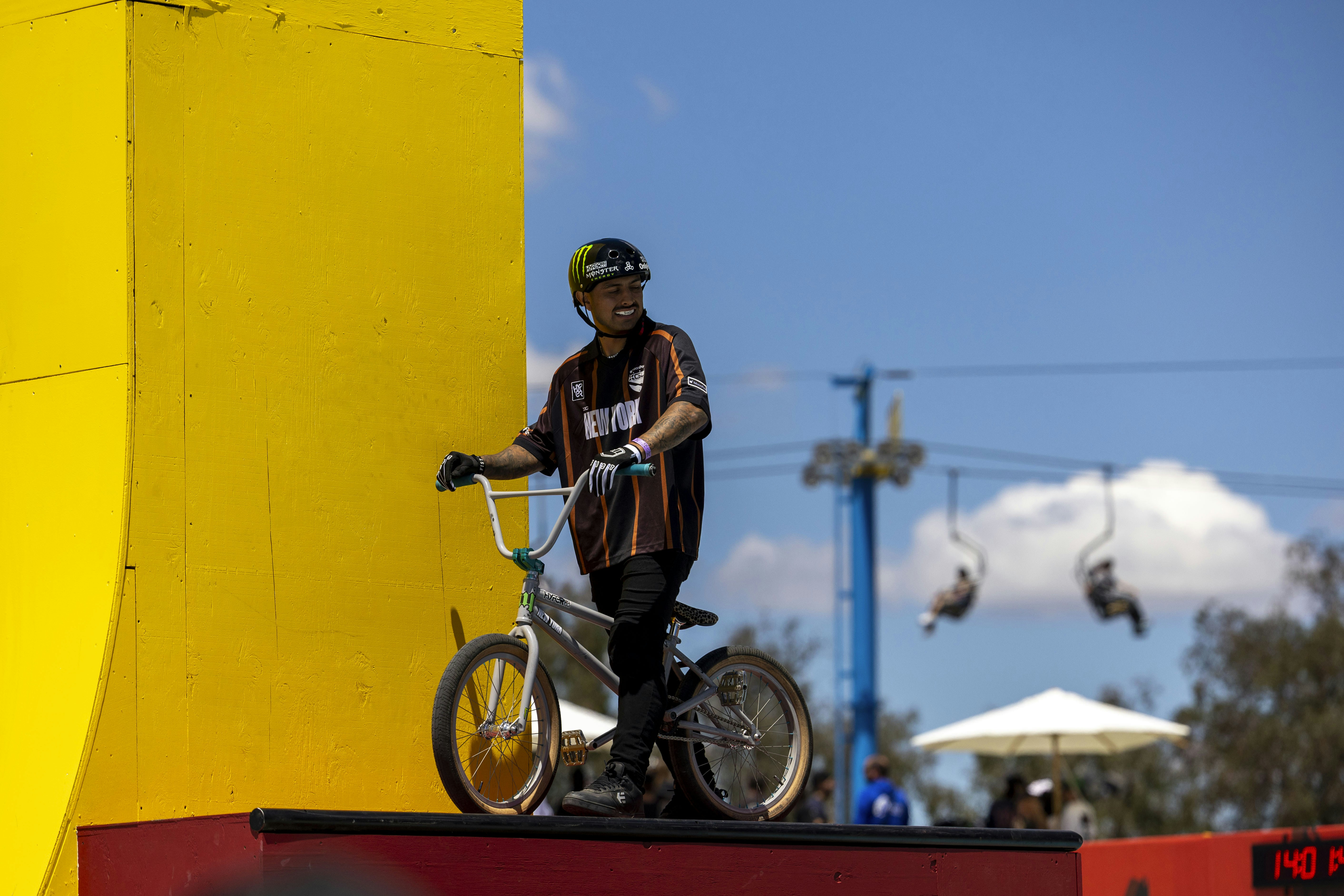 Rider on a Yellow Ramp: BMX Moment Under a Clear Sky