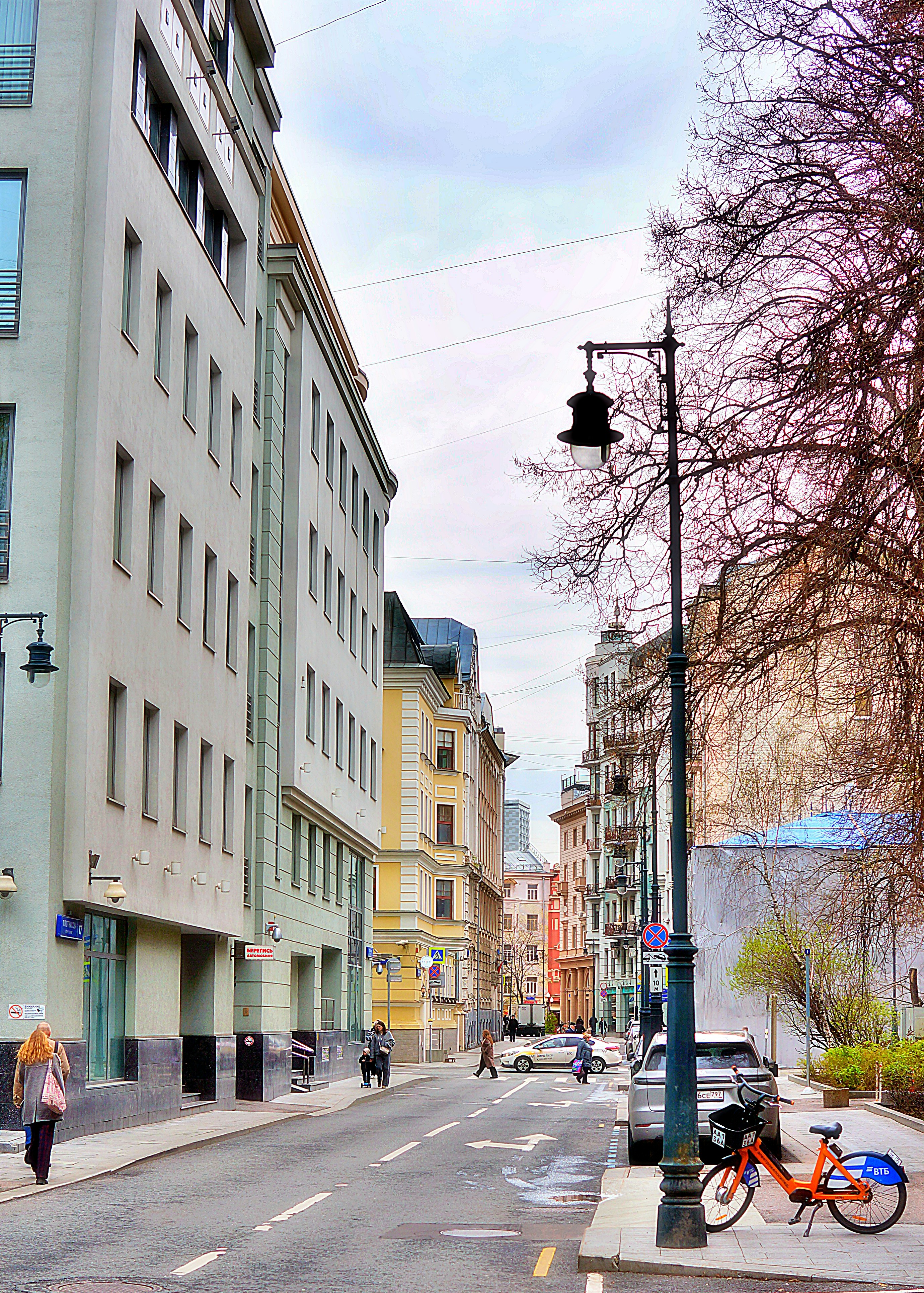 City Lane in Soft Light with Orange Bicycle at the Corner