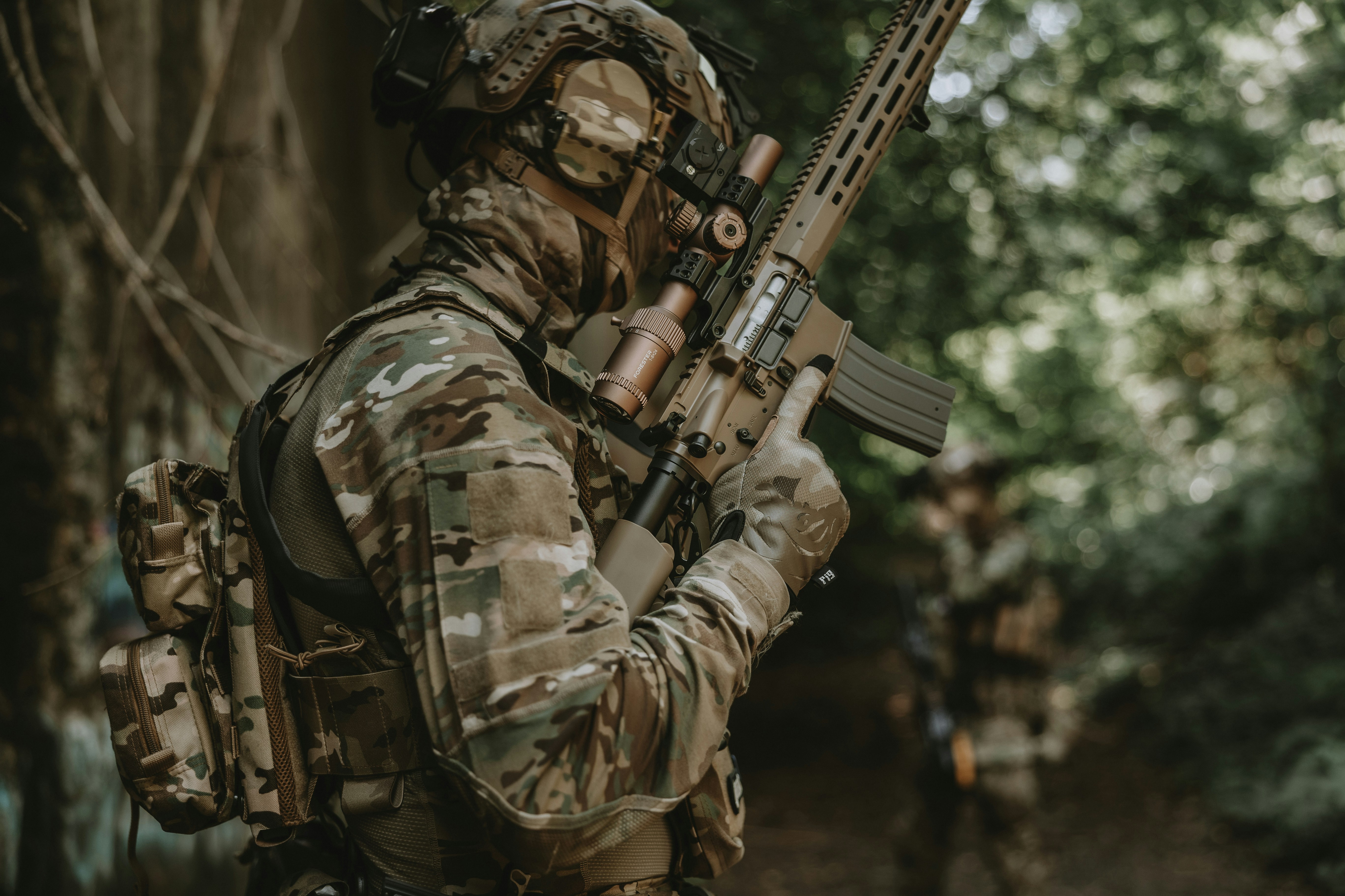 Camouflaged Sentinel with Rifle in a Forested Ambush