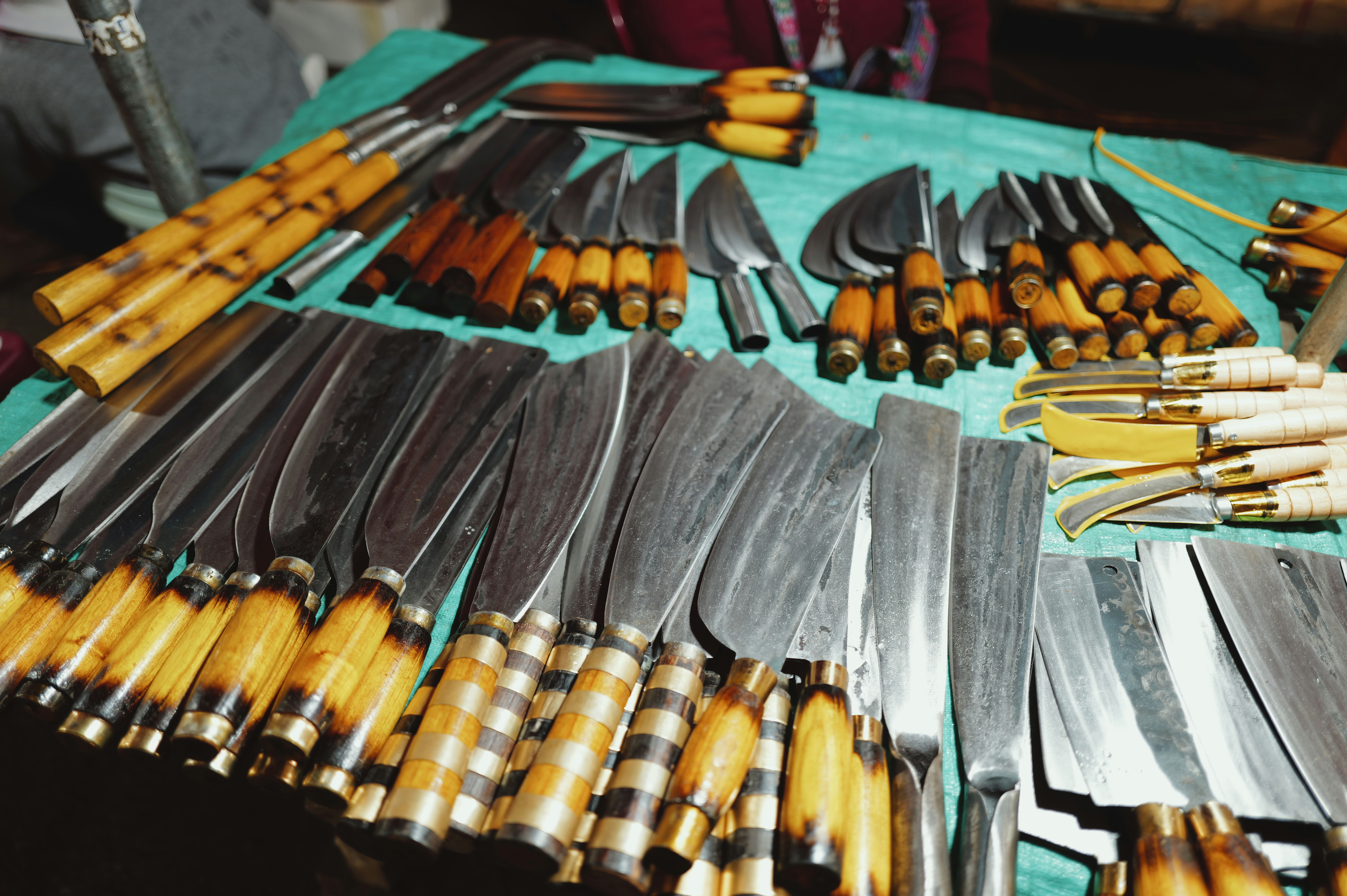 Blade Gallery: Hand-Tooled Knives on a Turquoise Cloth