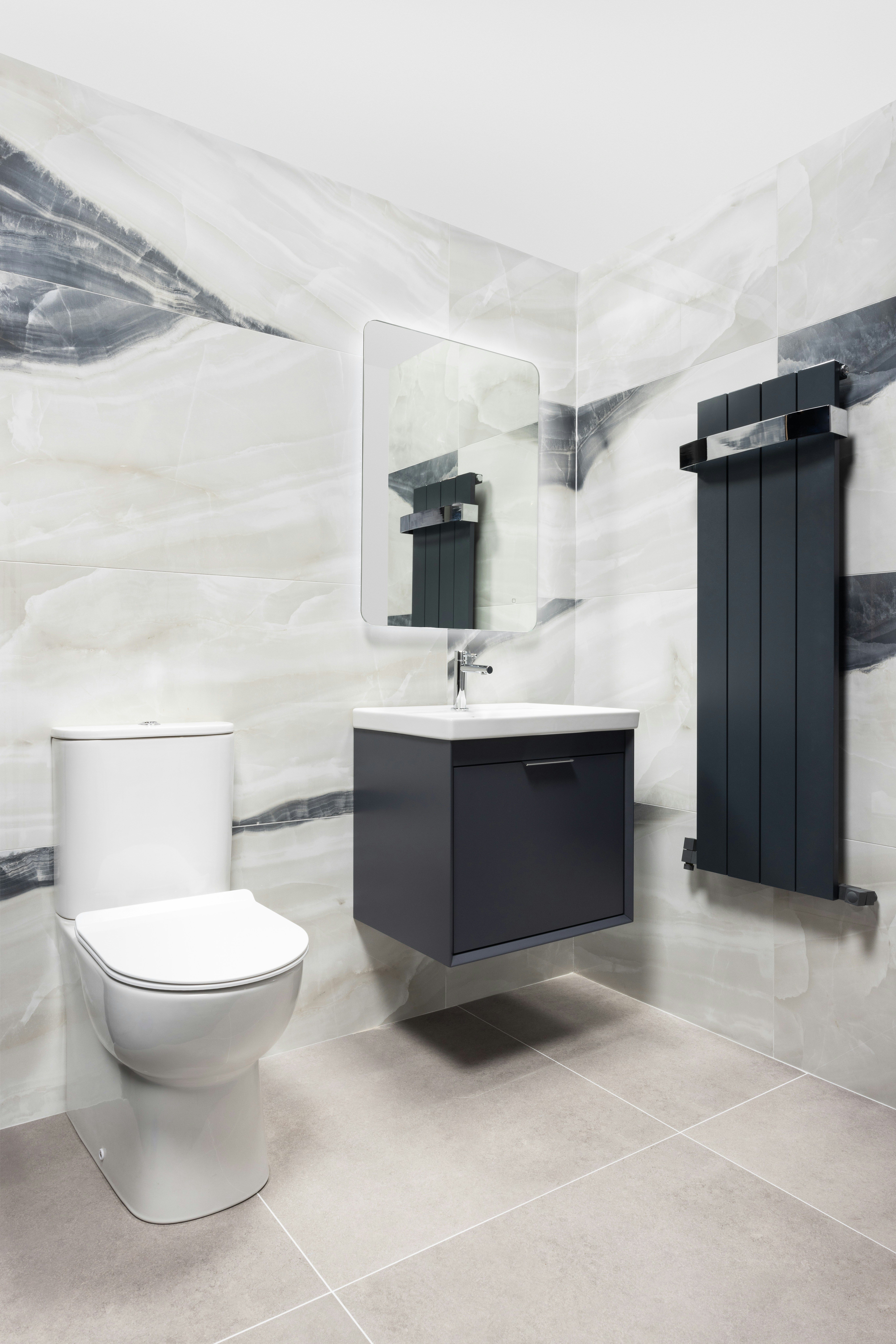 Minimalist Marble Bath: Floating Vanity and Tall Radiator in Monochrome Serenity