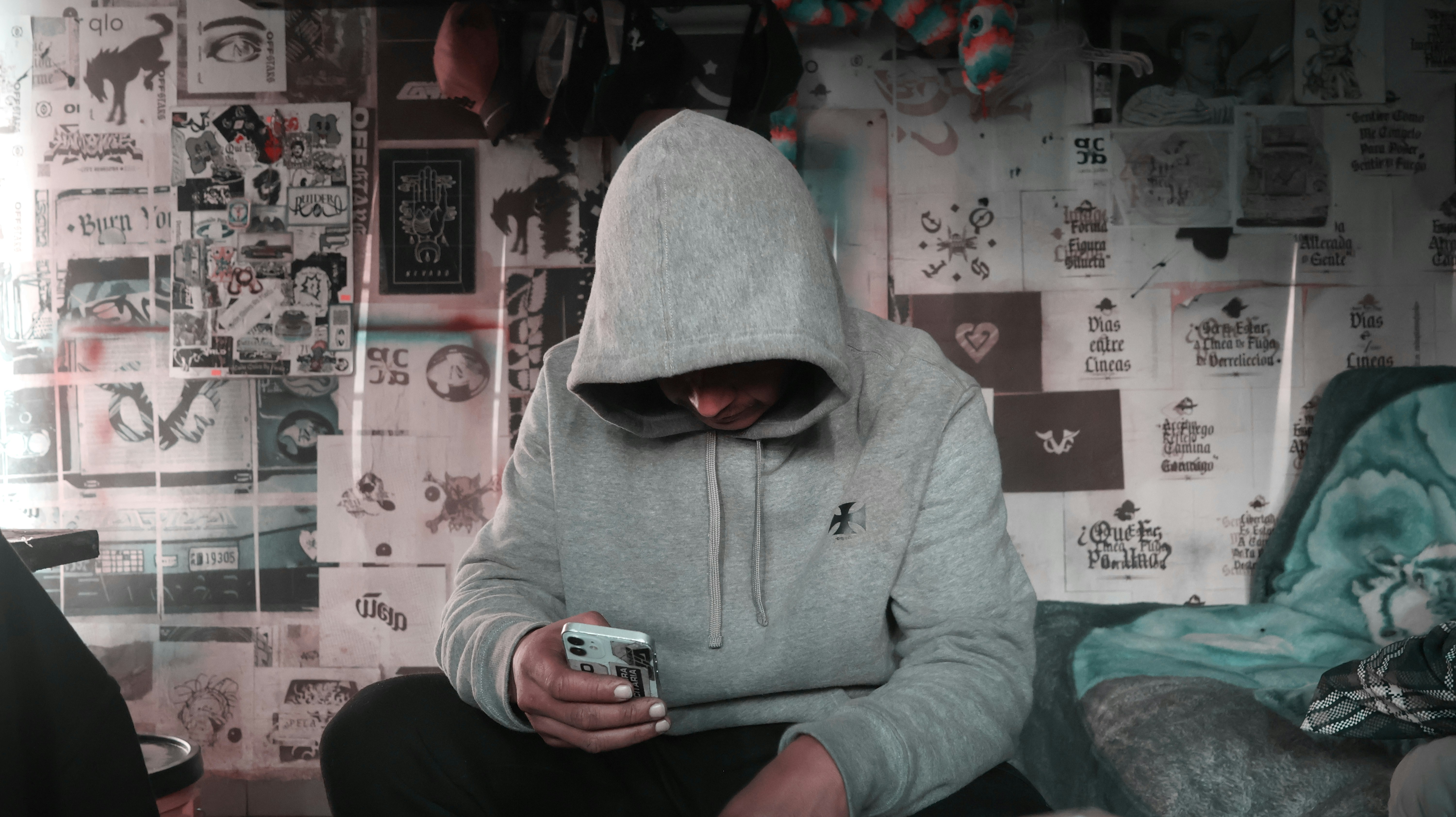 Hooded Focus: Quiet Moment with a Smartphone