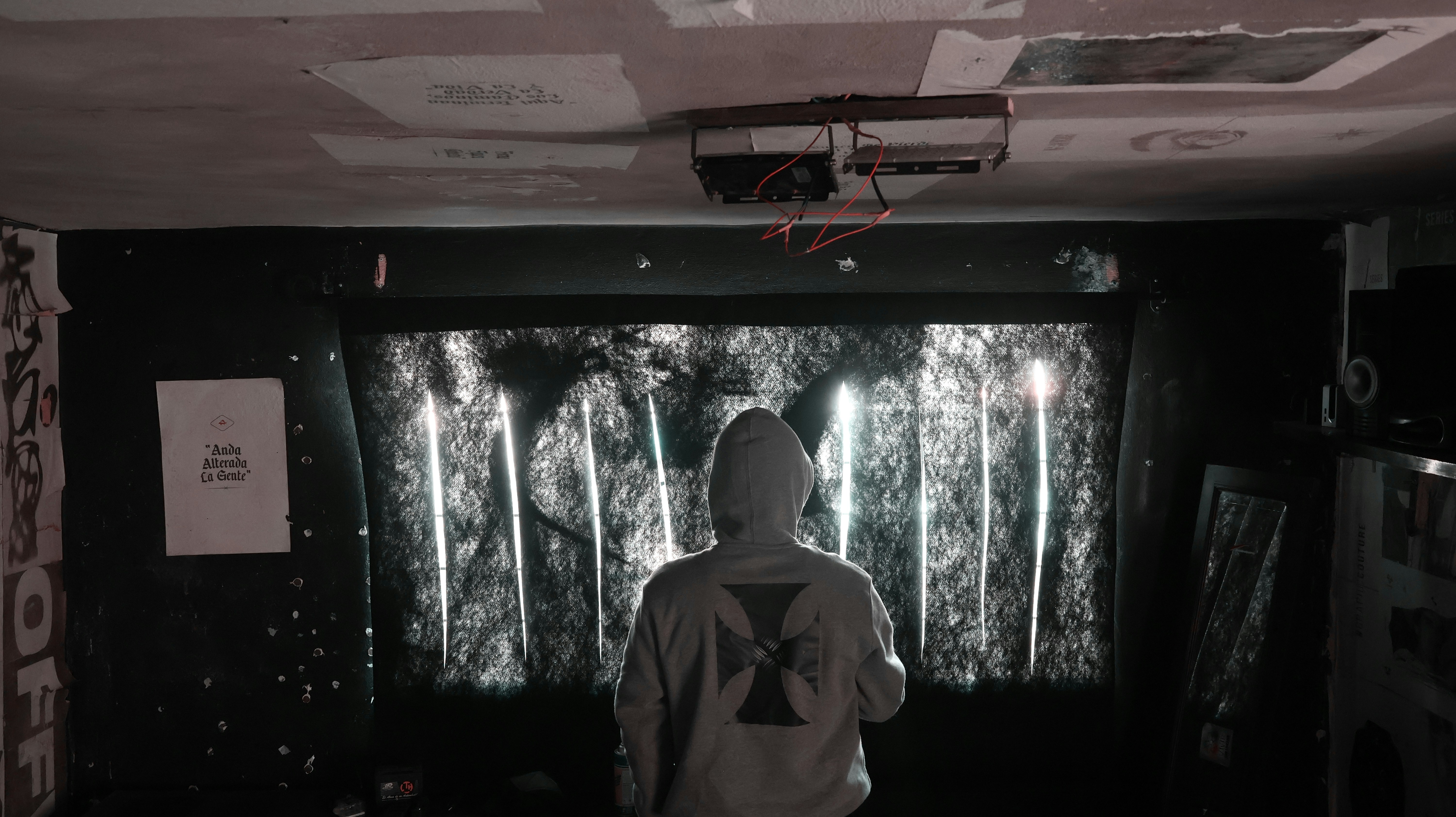 Hooded Figure in Neon-lit Tunnel of Static