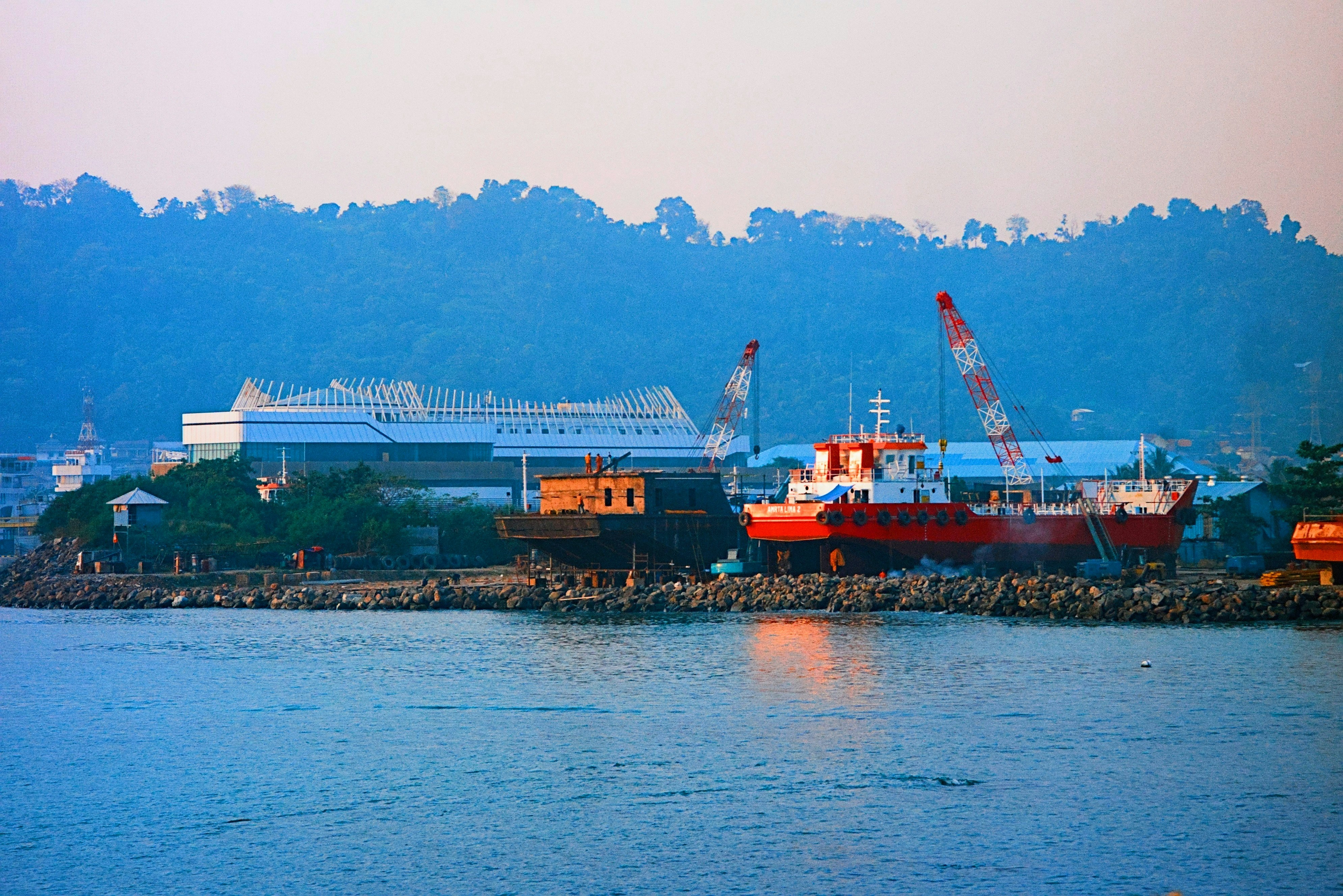 Harbor at Dusk: A Quiet Port Scene with Red Crane Boats