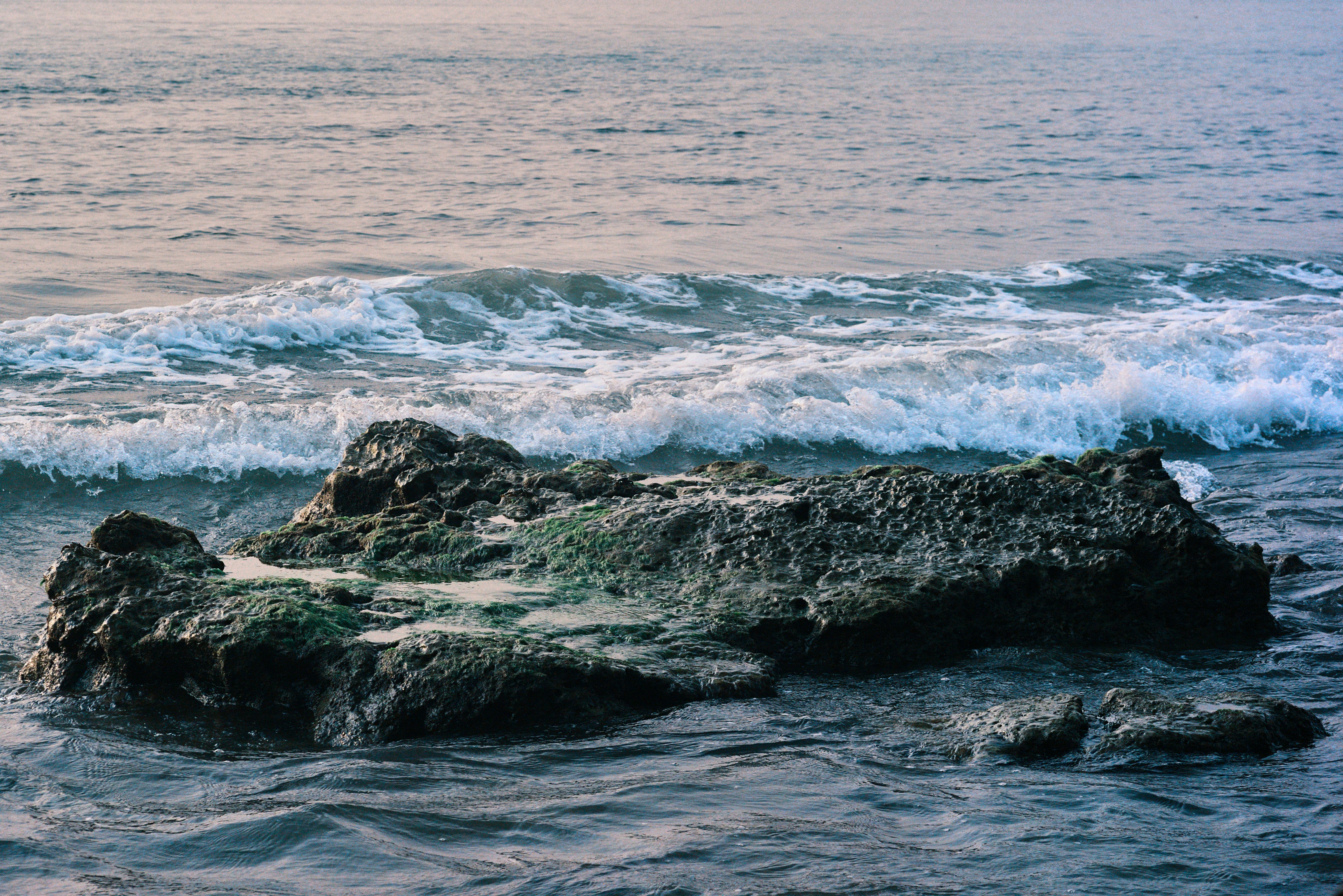 Rugged Tidework: Sunlit Rocks Guarding a Calm Horizon