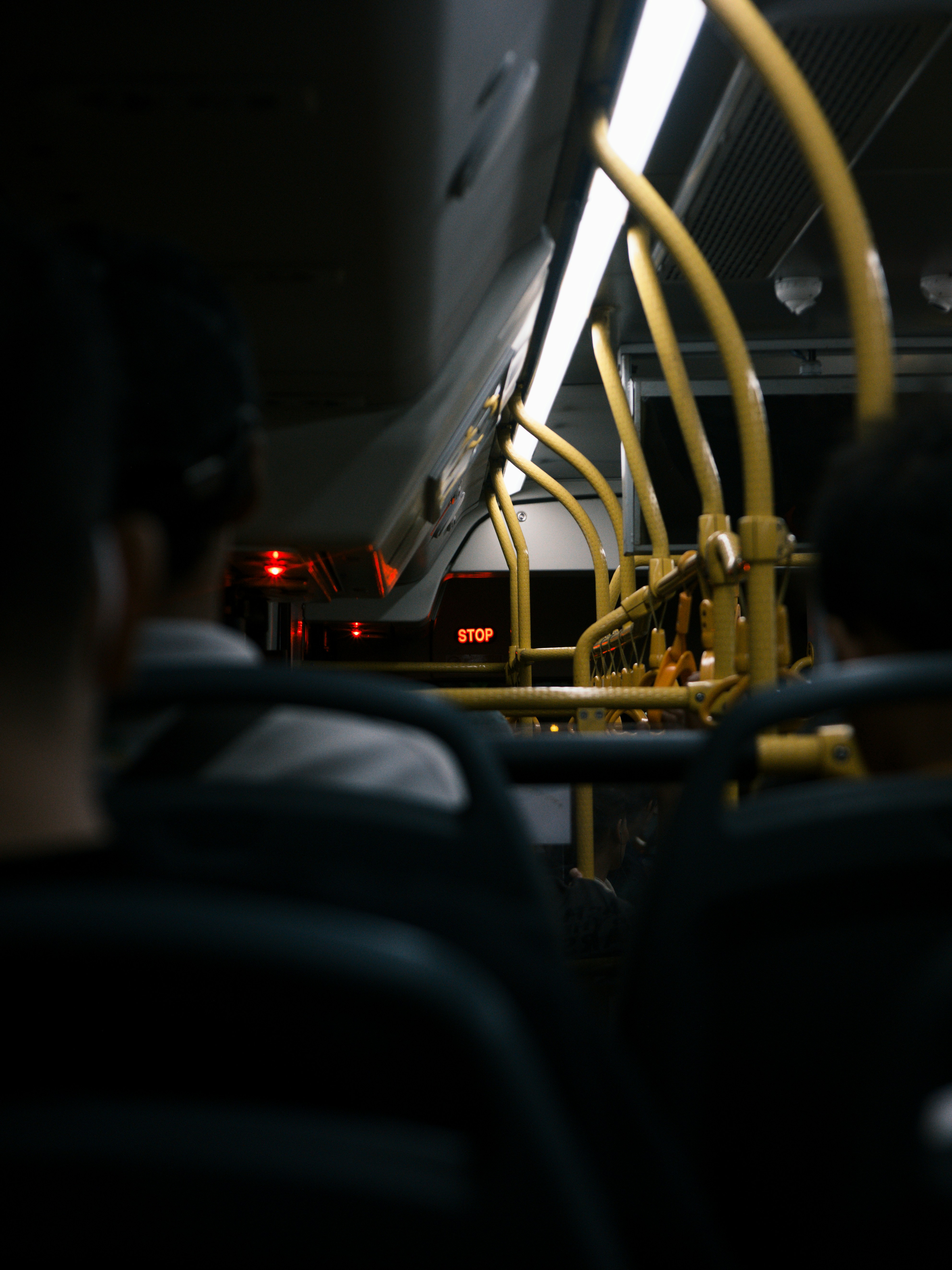 Midnight Stop: Neon Sign and Bus Interior Glow