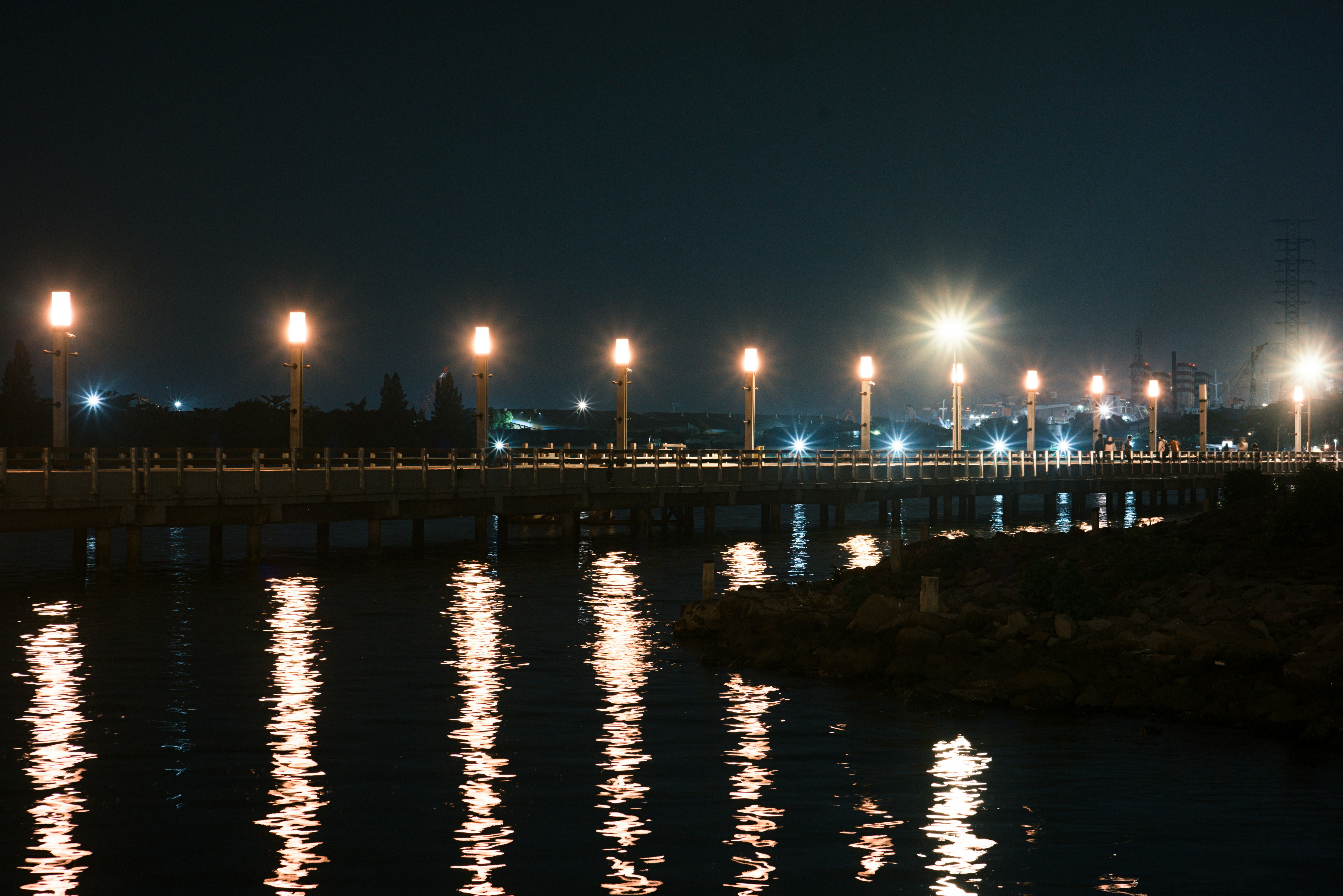 Luminous Pier: Reflections under Night Skies