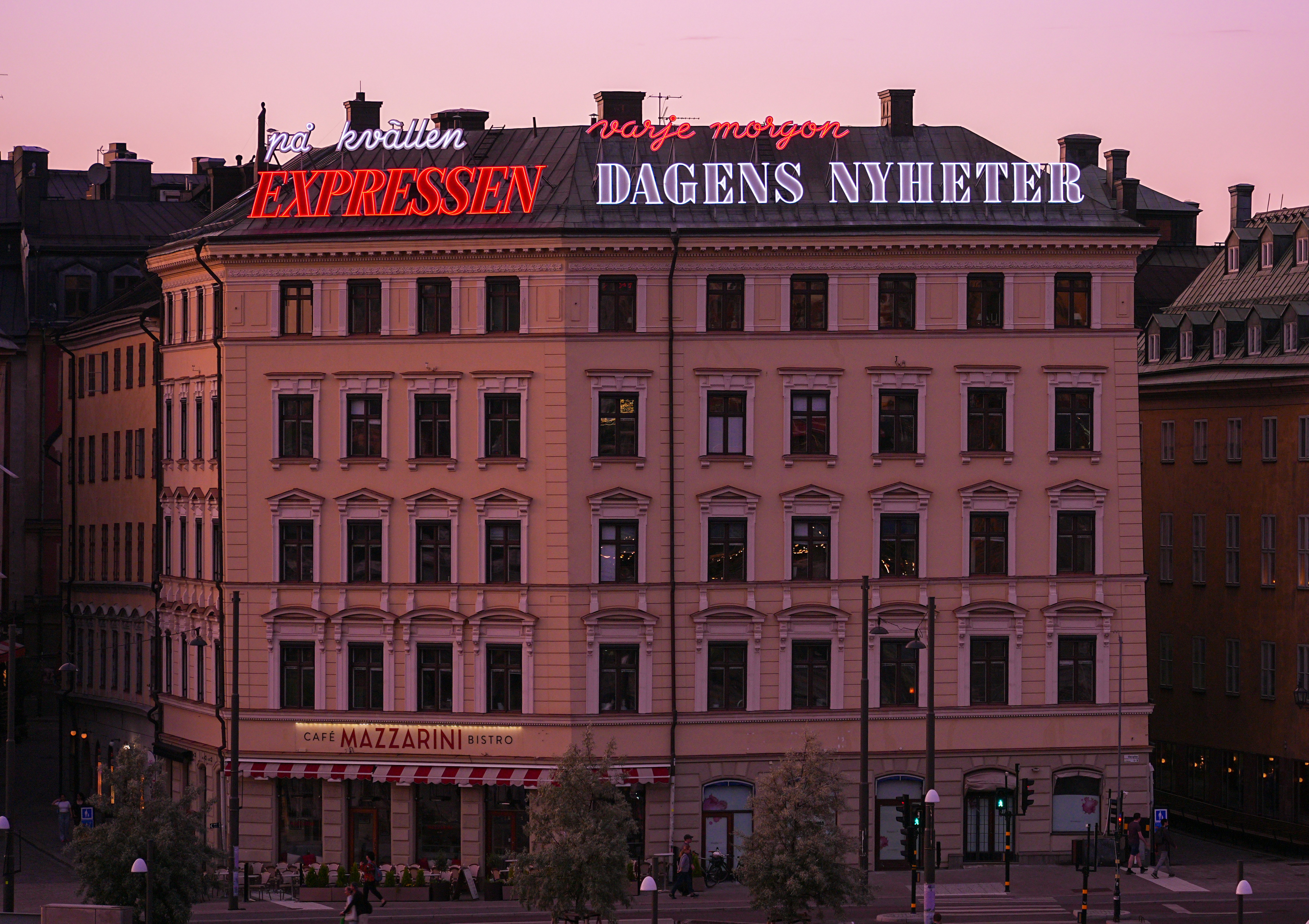 Neon Sign Over Rose-Colored Facade