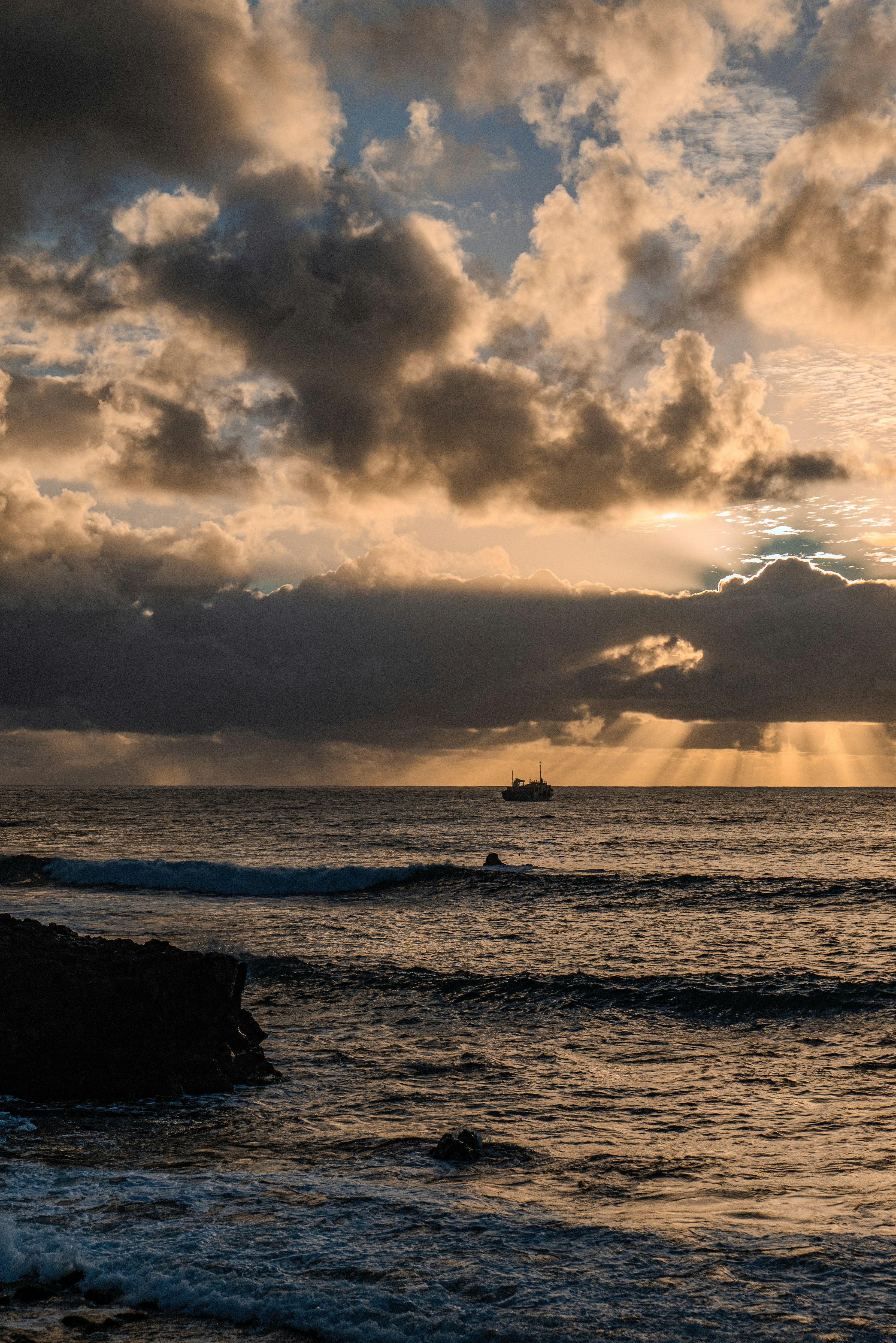 Sunbeams through the Clouds Over a Quiet Sea