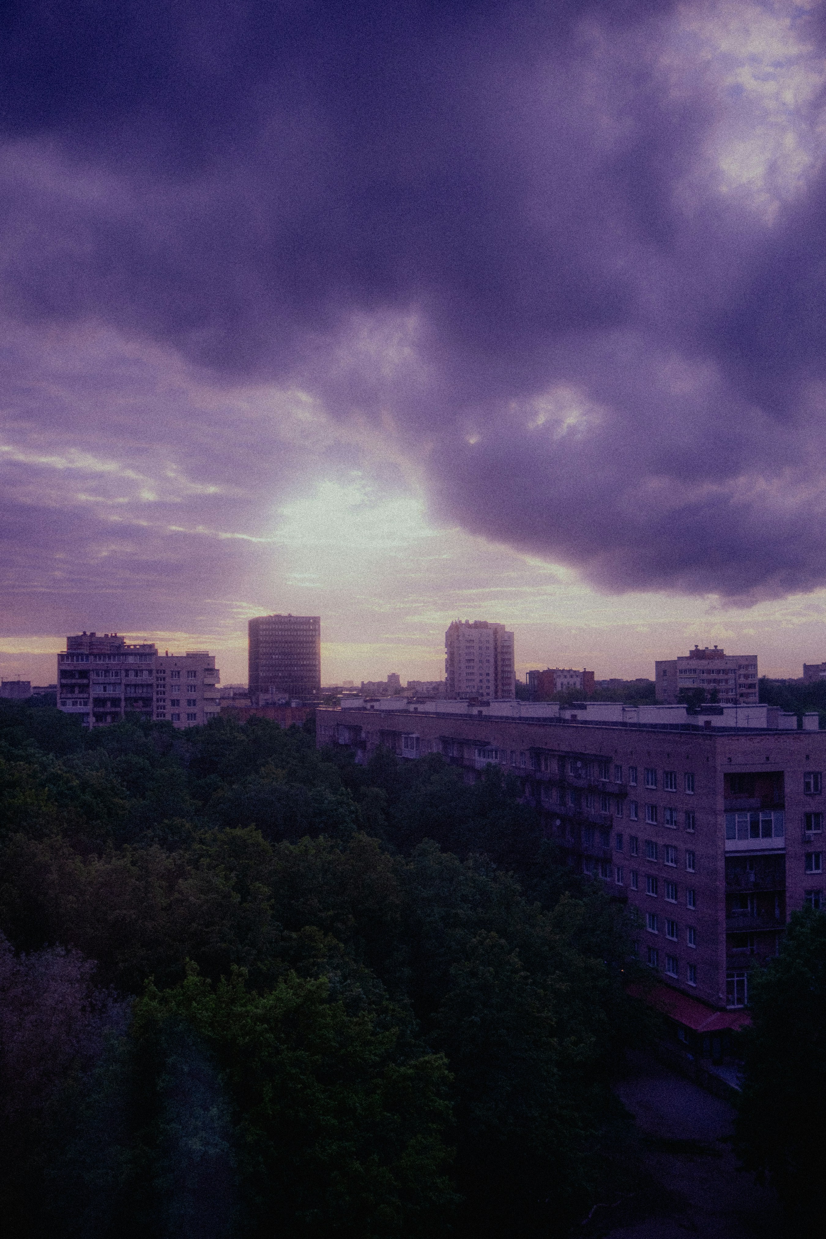 Urban Twilight Overcast: City Silhouette Beneath A Looming Cloud Bank