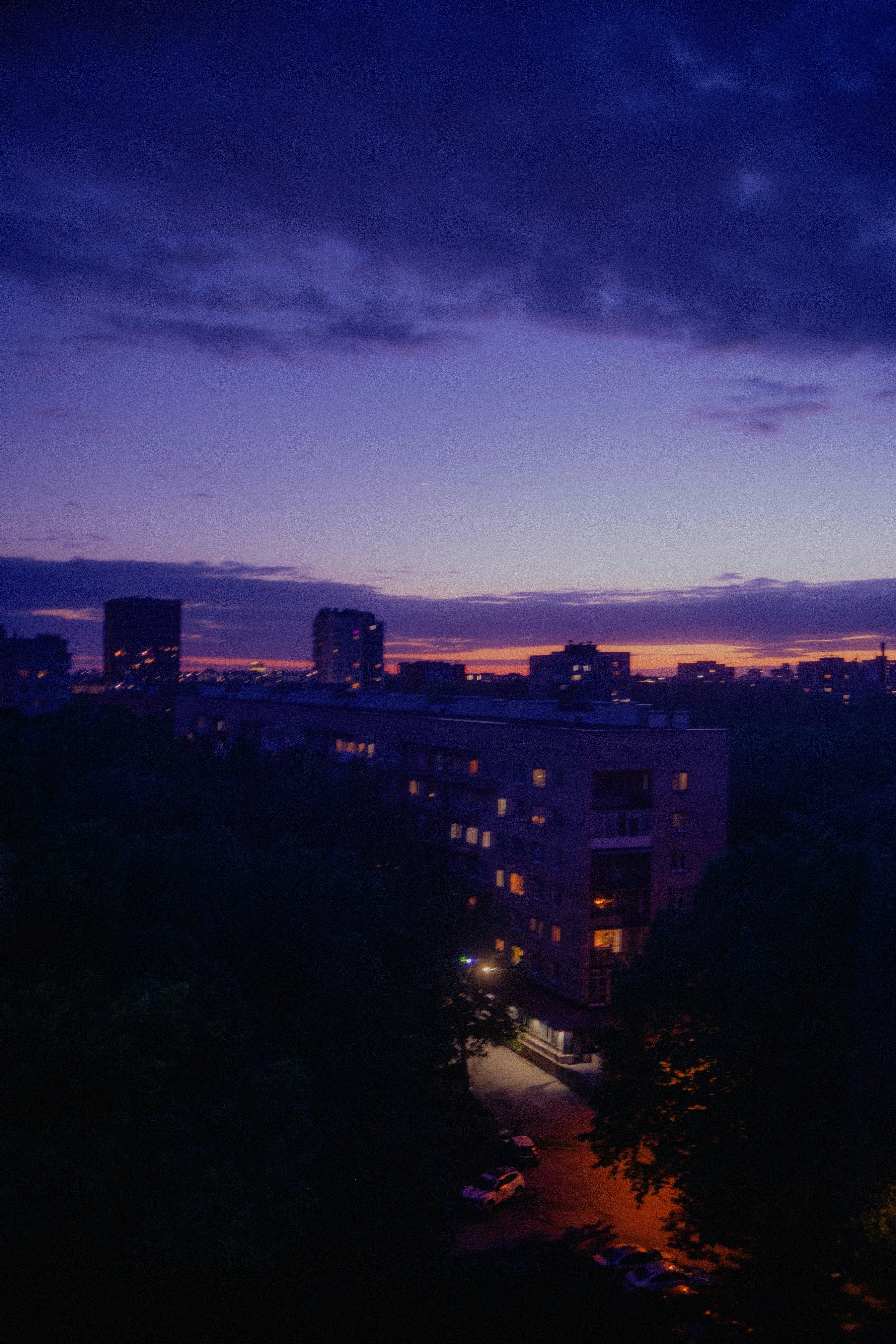 Twilight Apartments: Quiet Street Amid Dusked Skyline