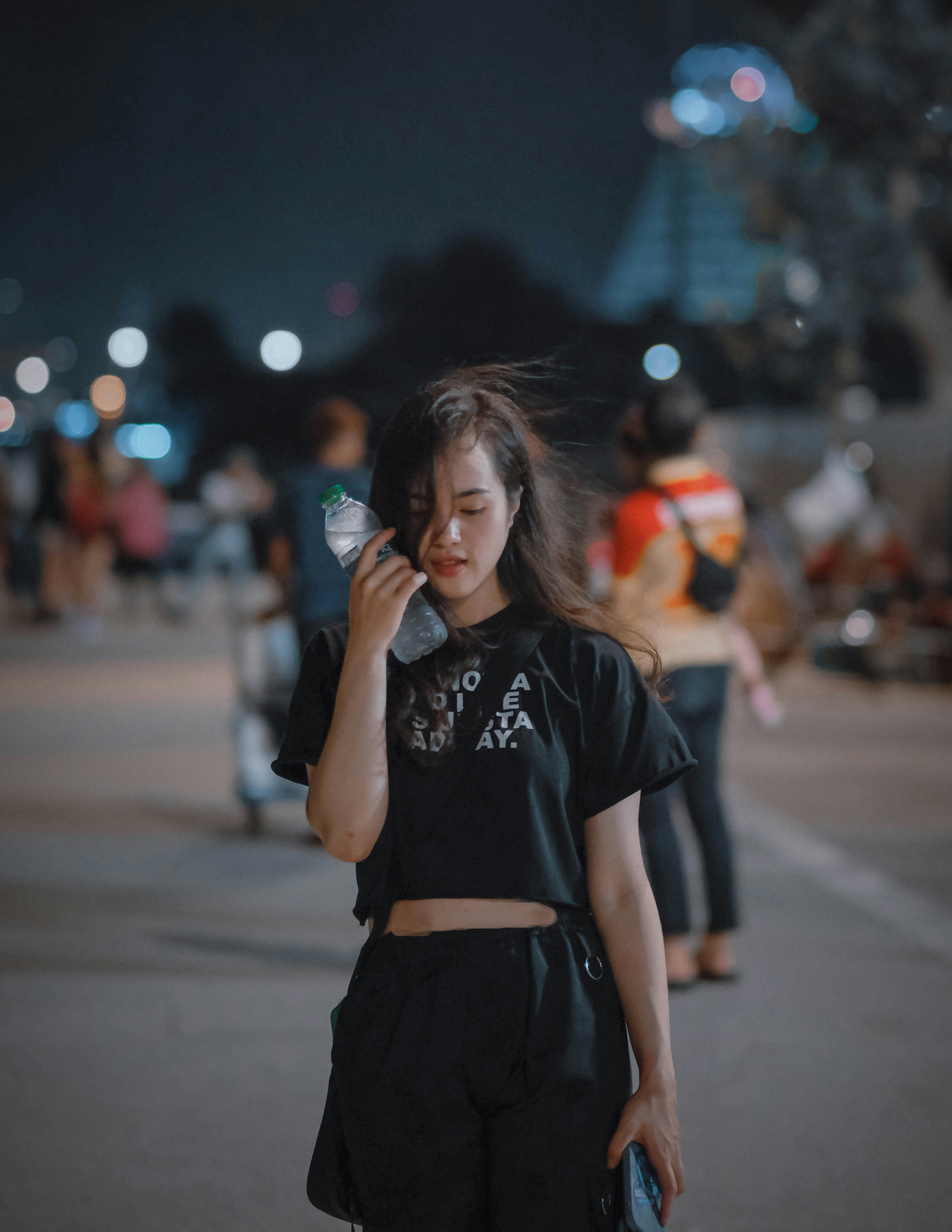 Night Walk: A Quiet Moment with a Water Bottle Under Neon Sky
