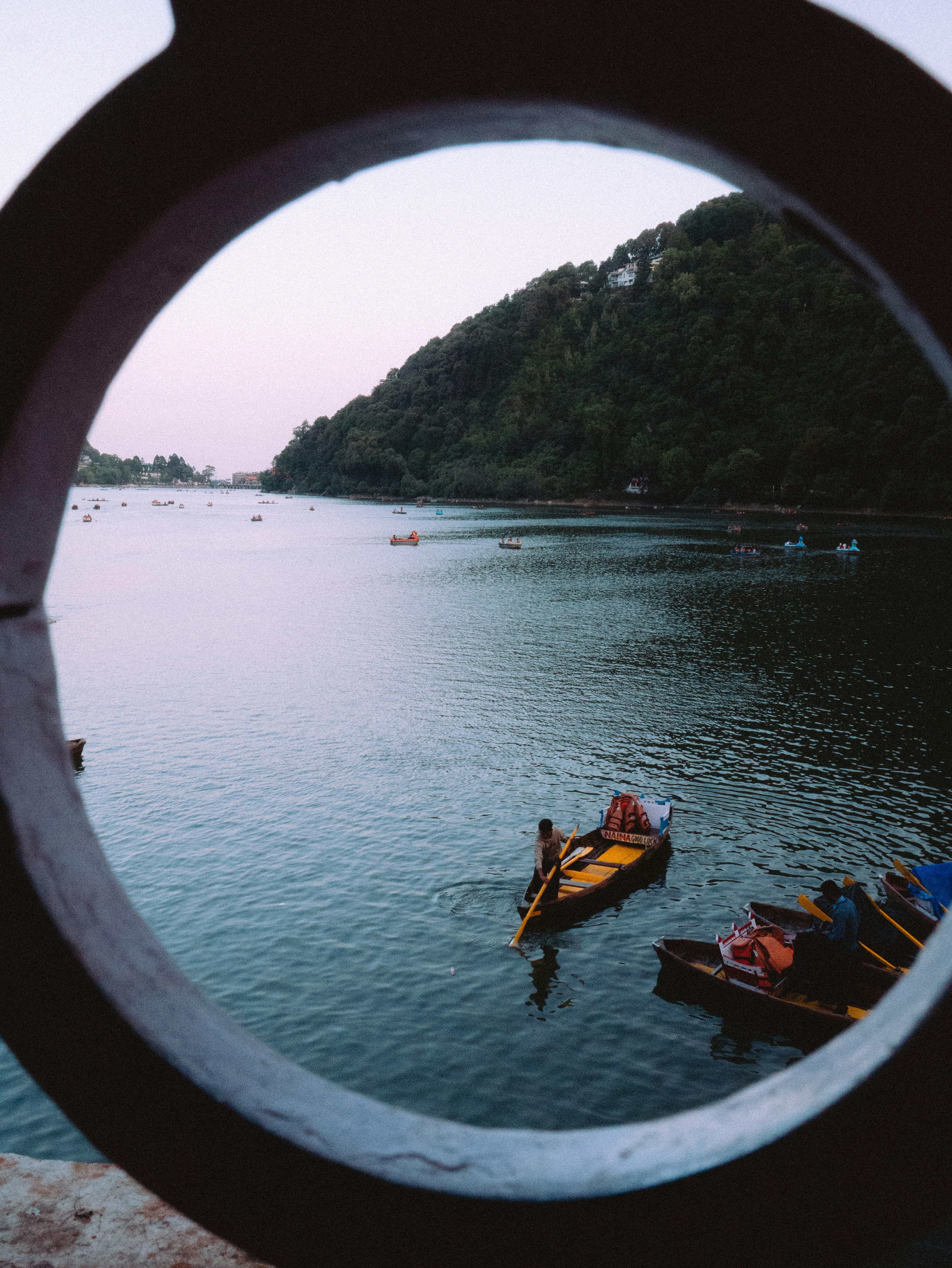 Circular Window to Calm Waters: Boats Framing a Quiet Bay