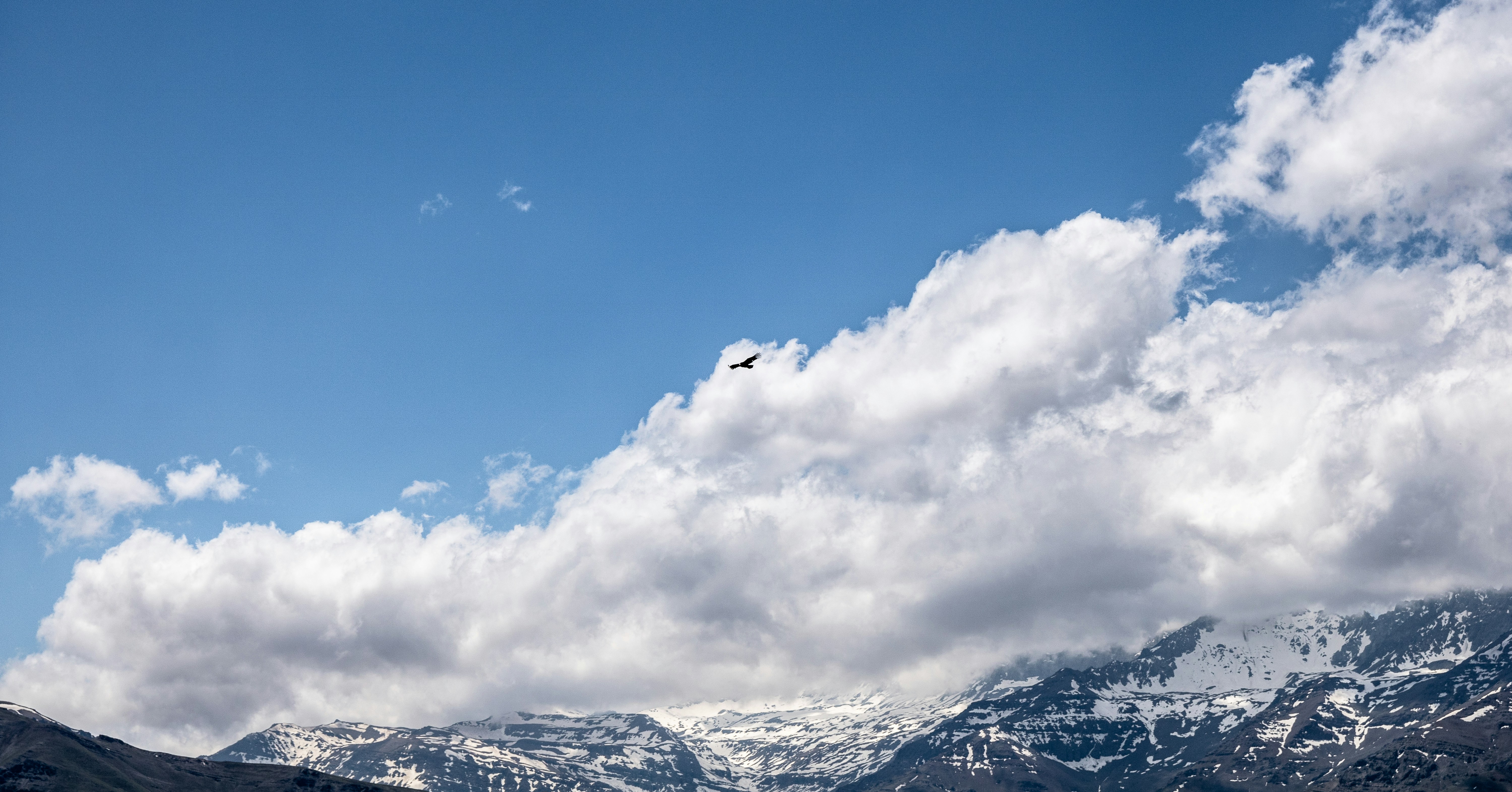 Snow-Capped Ridge Under a Luminous Alpine Sky