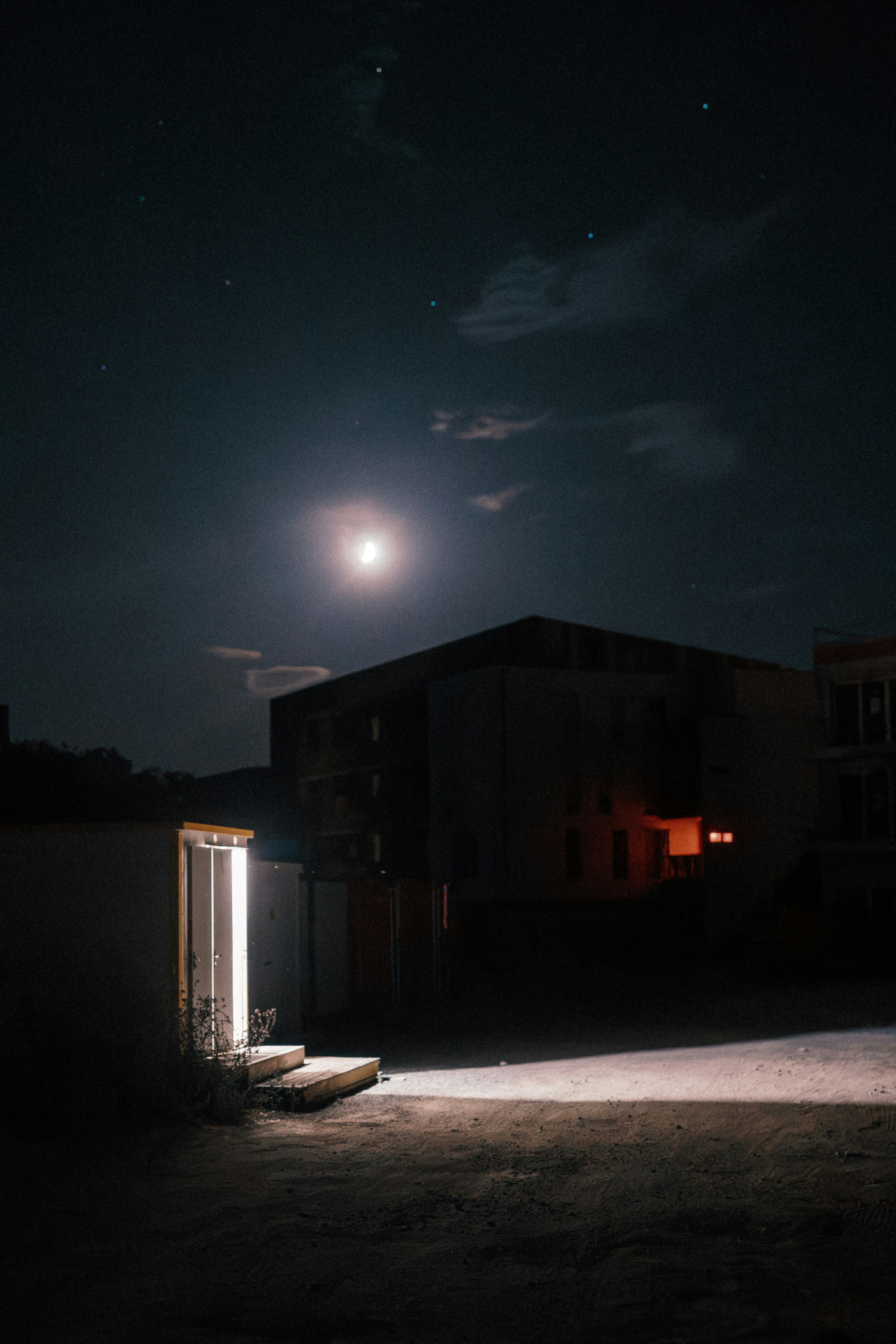 Moonlit Porch: Quiet Night at the Edge of a Building Yard