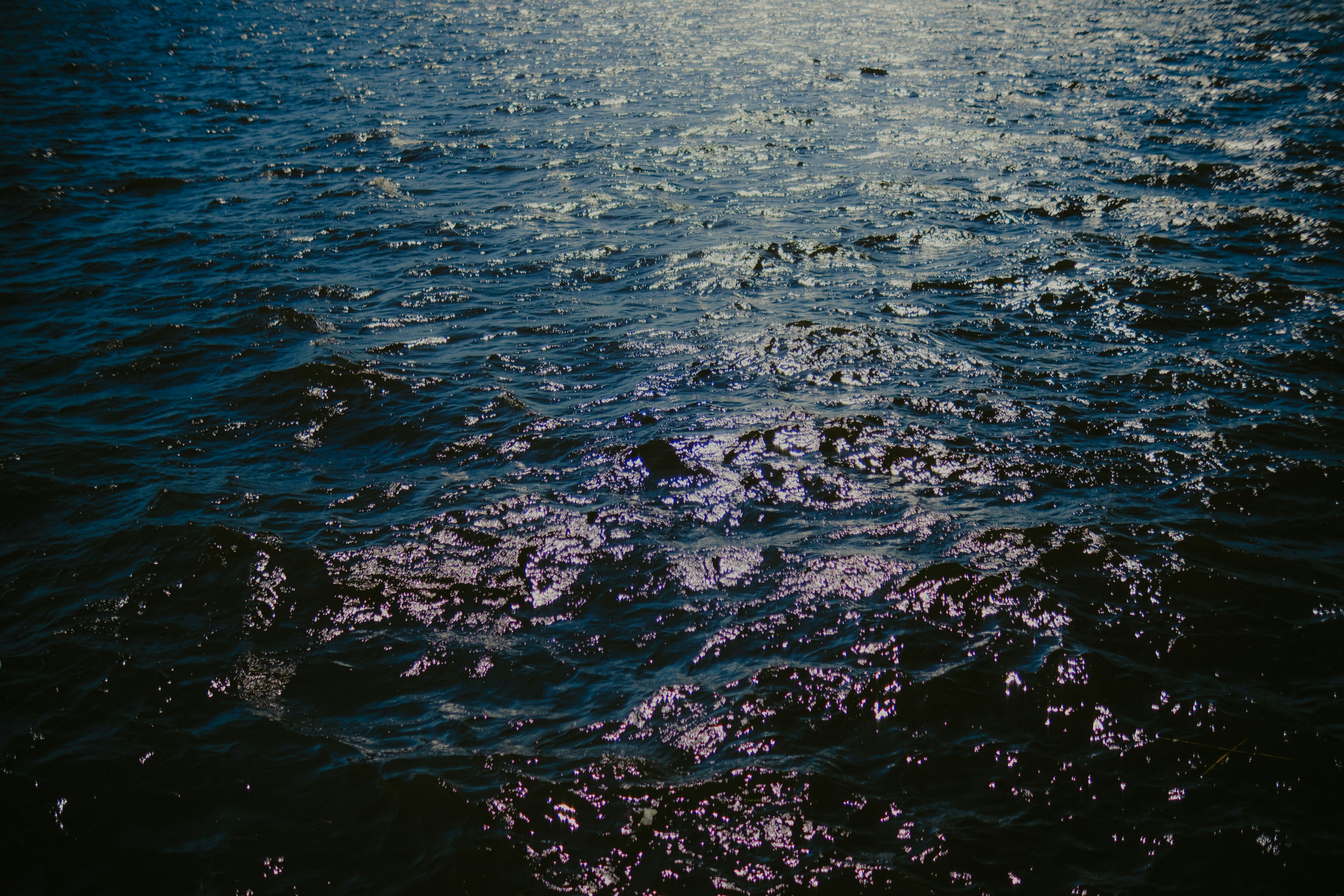 Glittering Ocean: Sunlit Ripples Across a Distant Surface