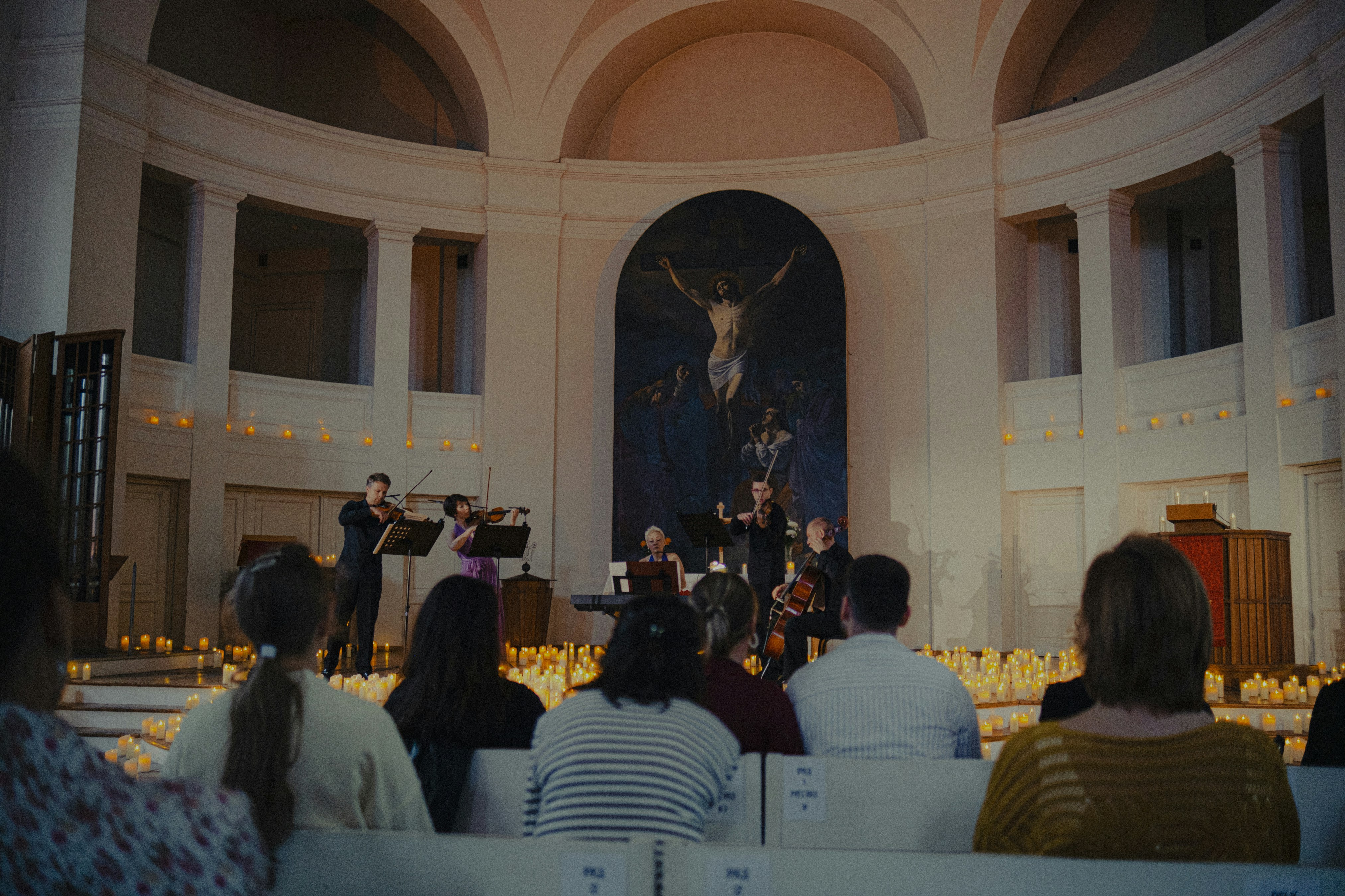 Silent Hall Serenade: Musicians in a Candlelit Oasis