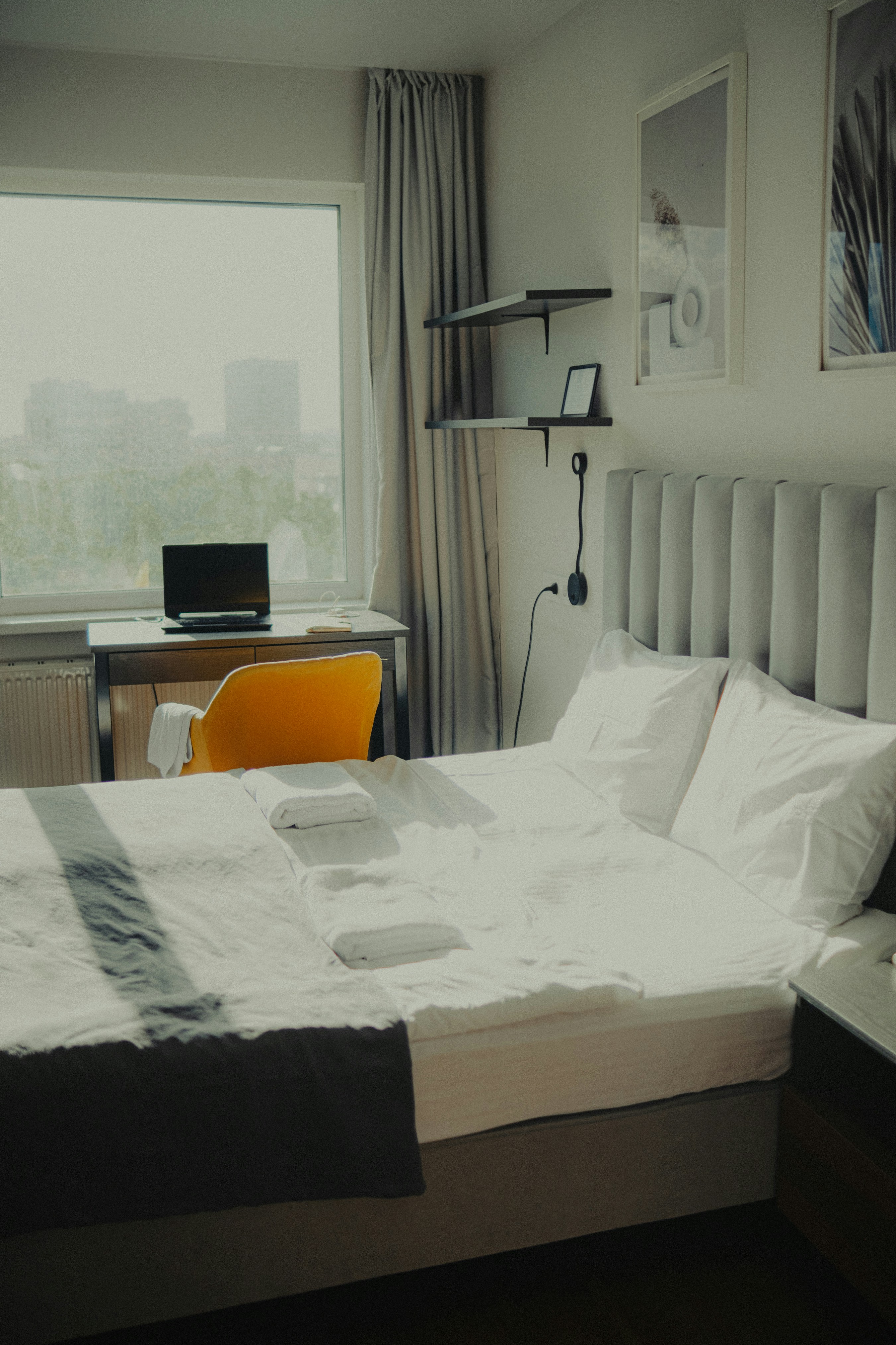 Quiet Comfort: A Sunlit Hotel Room with a Bright Orange Chair