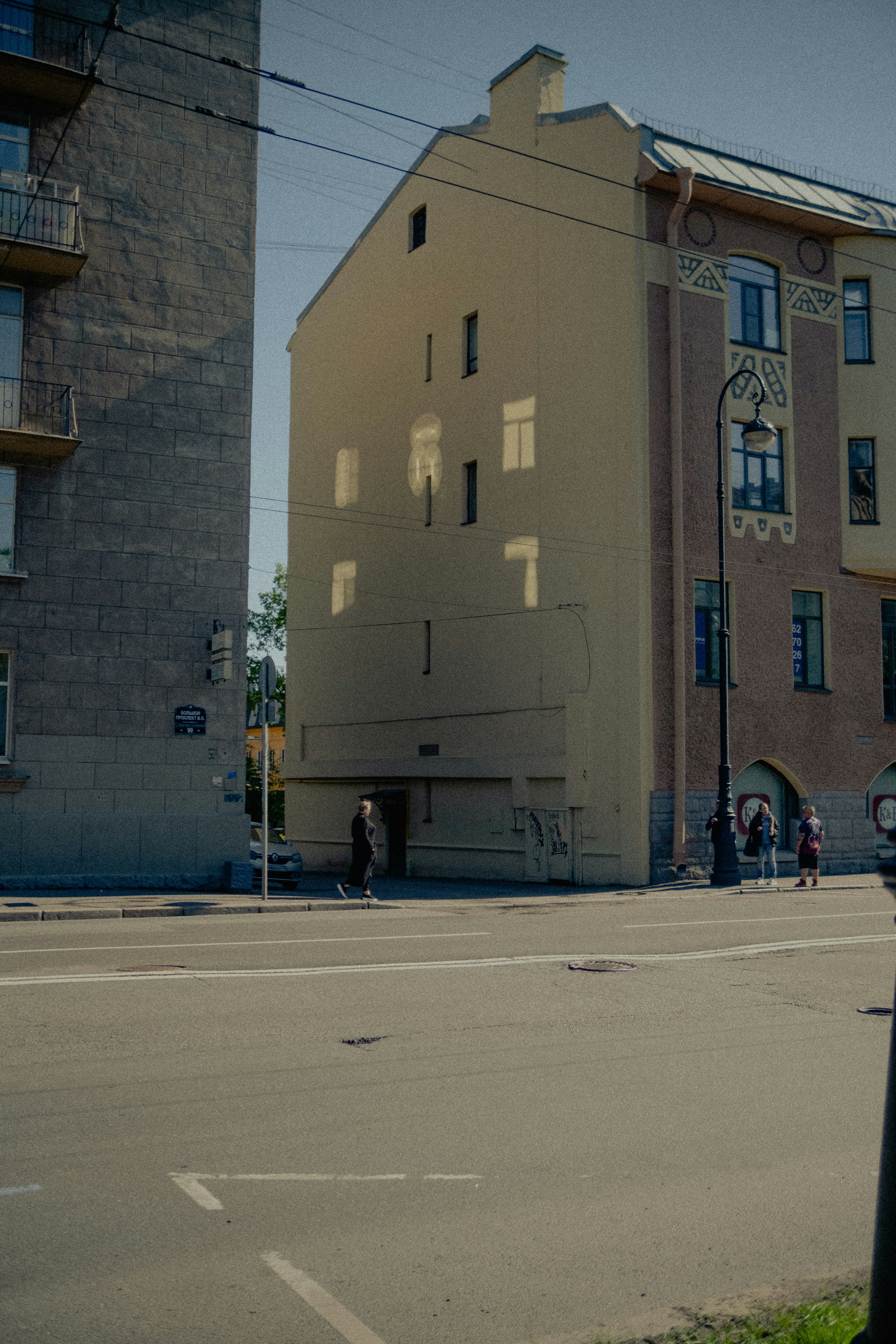 Sunlit Corner: Facade and Street Life on a Quiet Urban Avenue