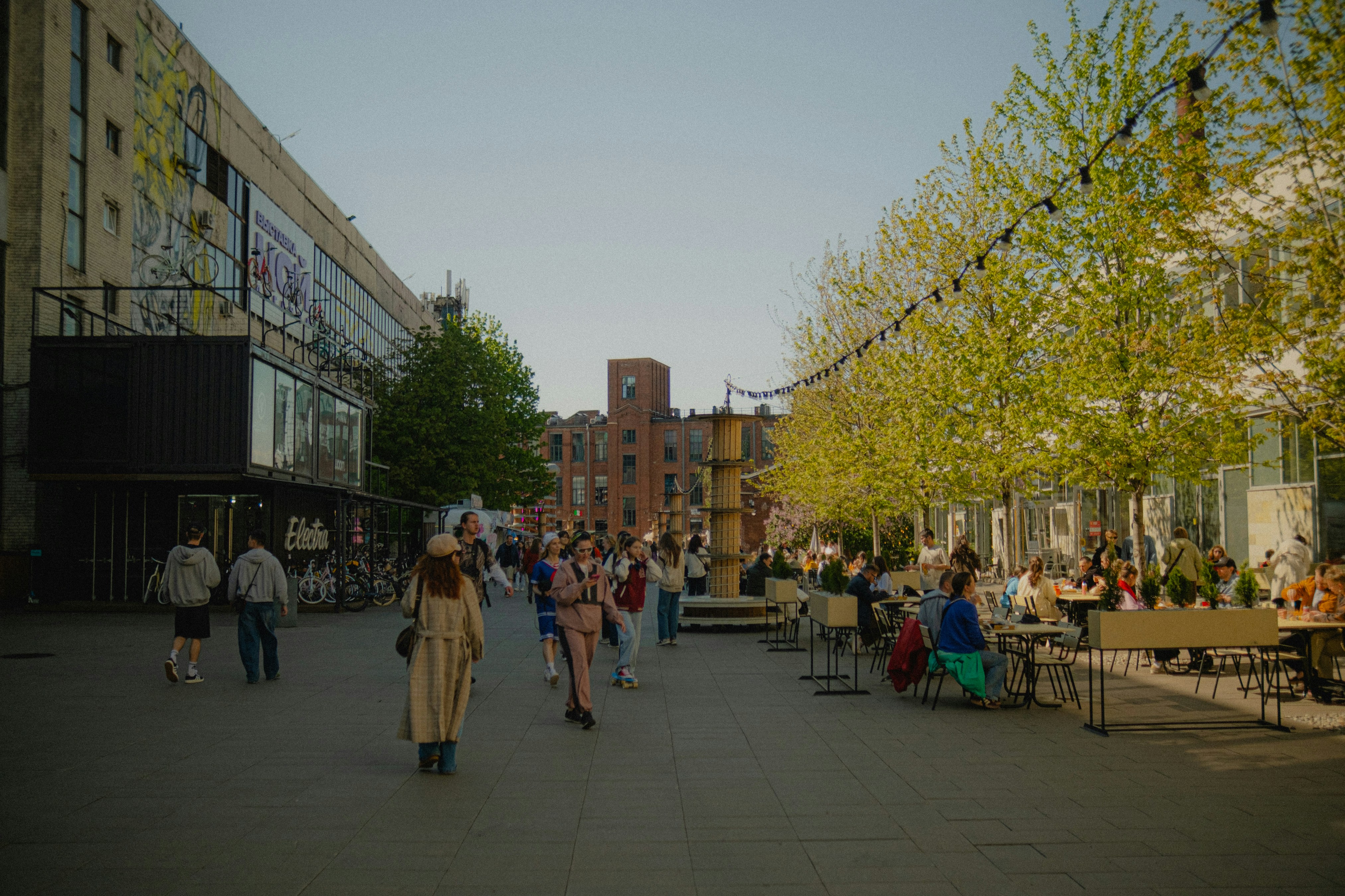 Café glow on a sunlit urban plaza