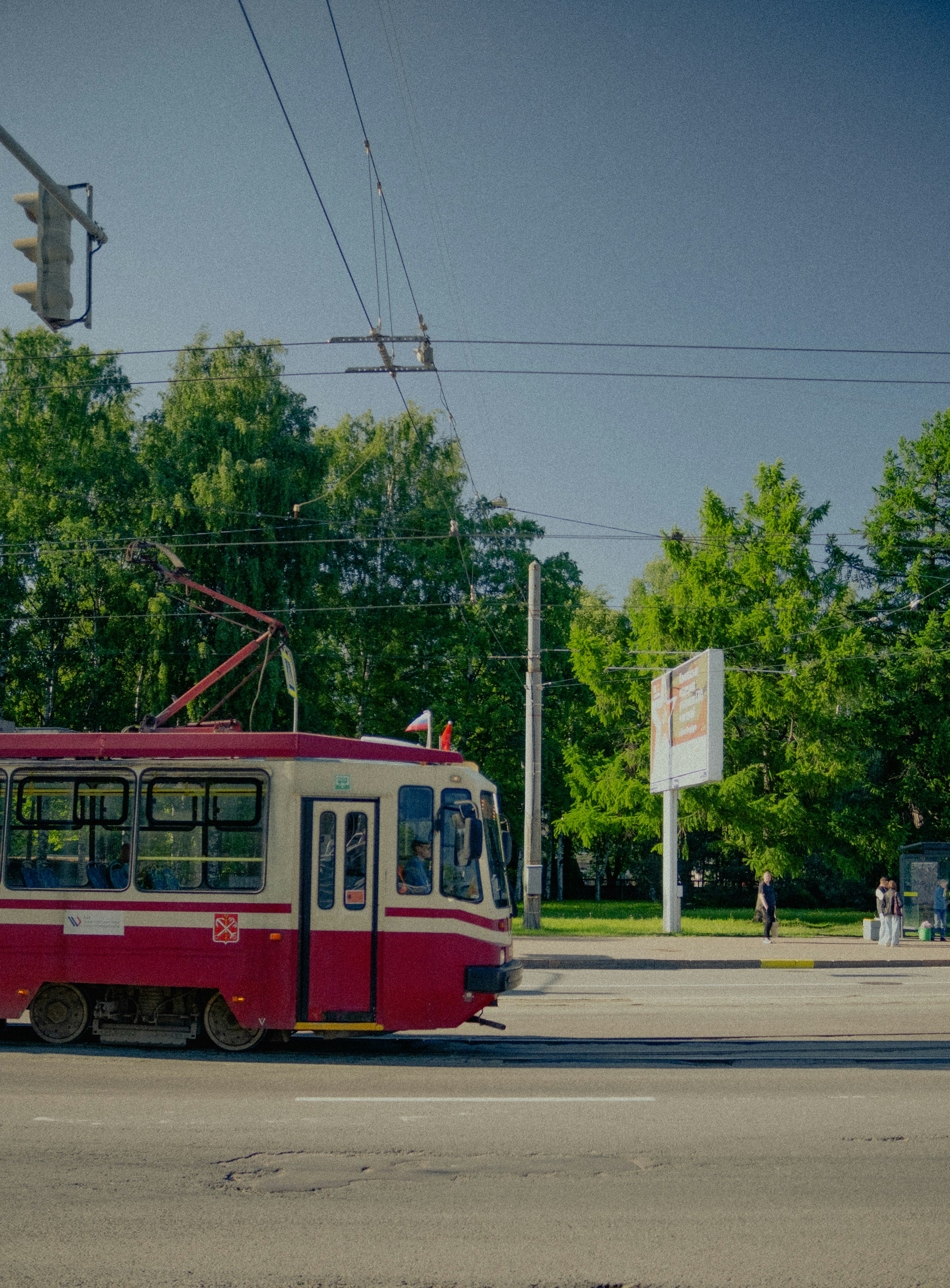 Pink Tram Gliding Past a Quiet Street