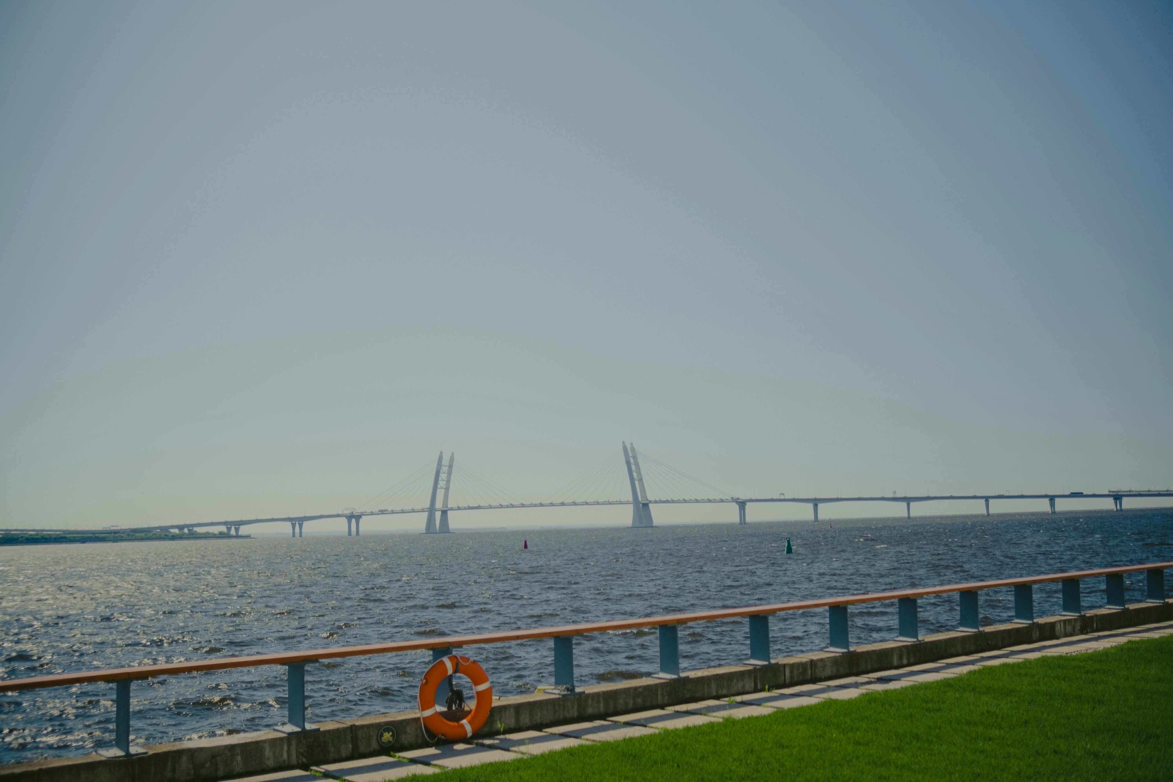 Edge of the Bay: Lifebuoy and Bridge Silhouette by the Sea