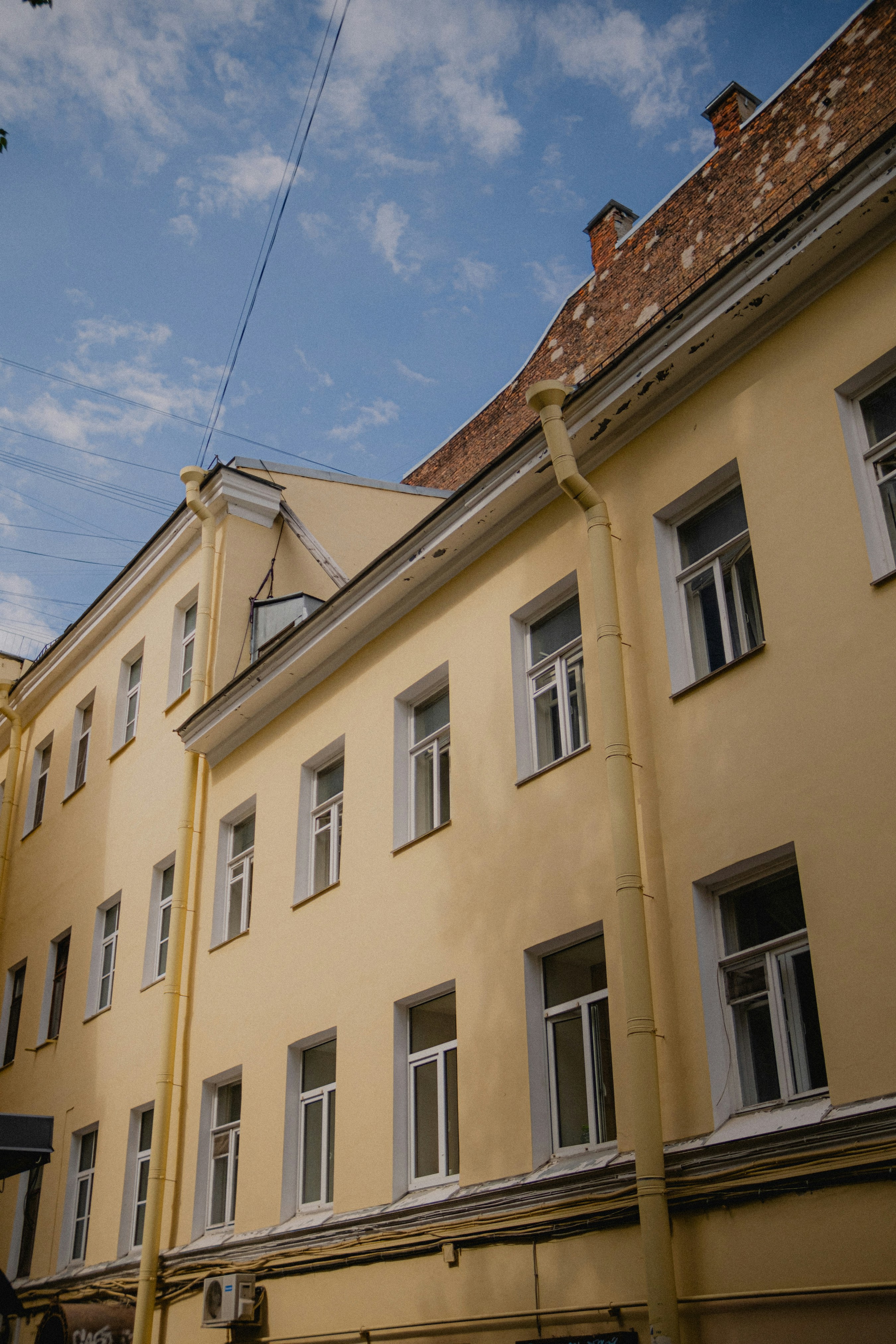 Sunlit Yellow Facade under a Wide Blue Sky