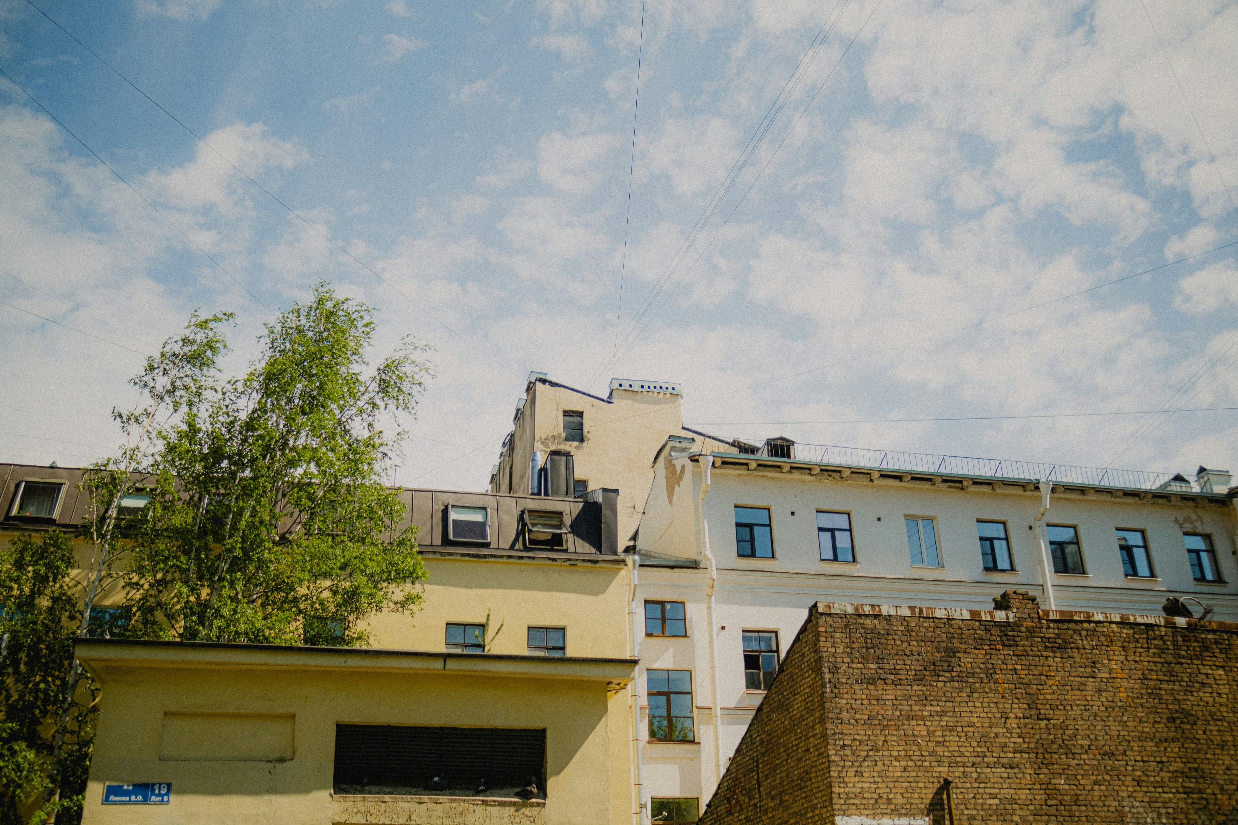 Sunlit Blocks and Sky: A Low-Angle Snapshot of Urban Facades