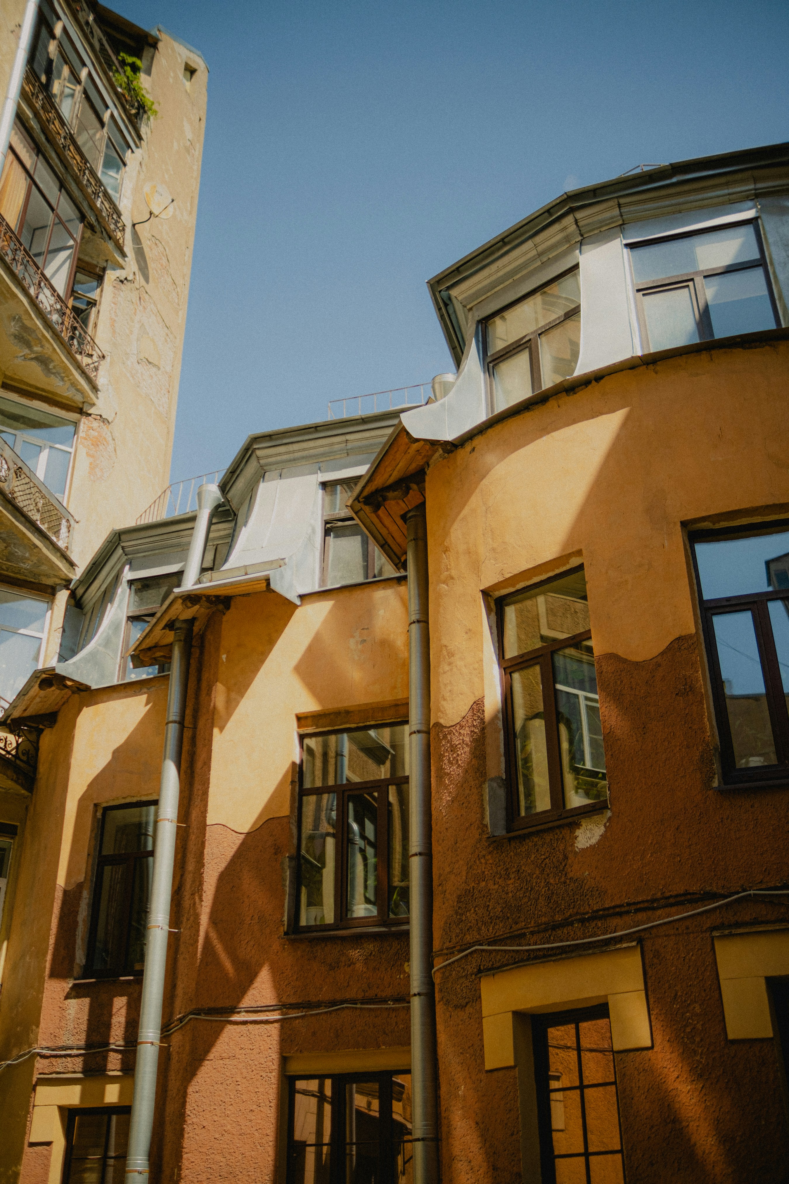 Sunlit Facade: A Warm Facade of Mellow Orange Curves and Shadowed Windows