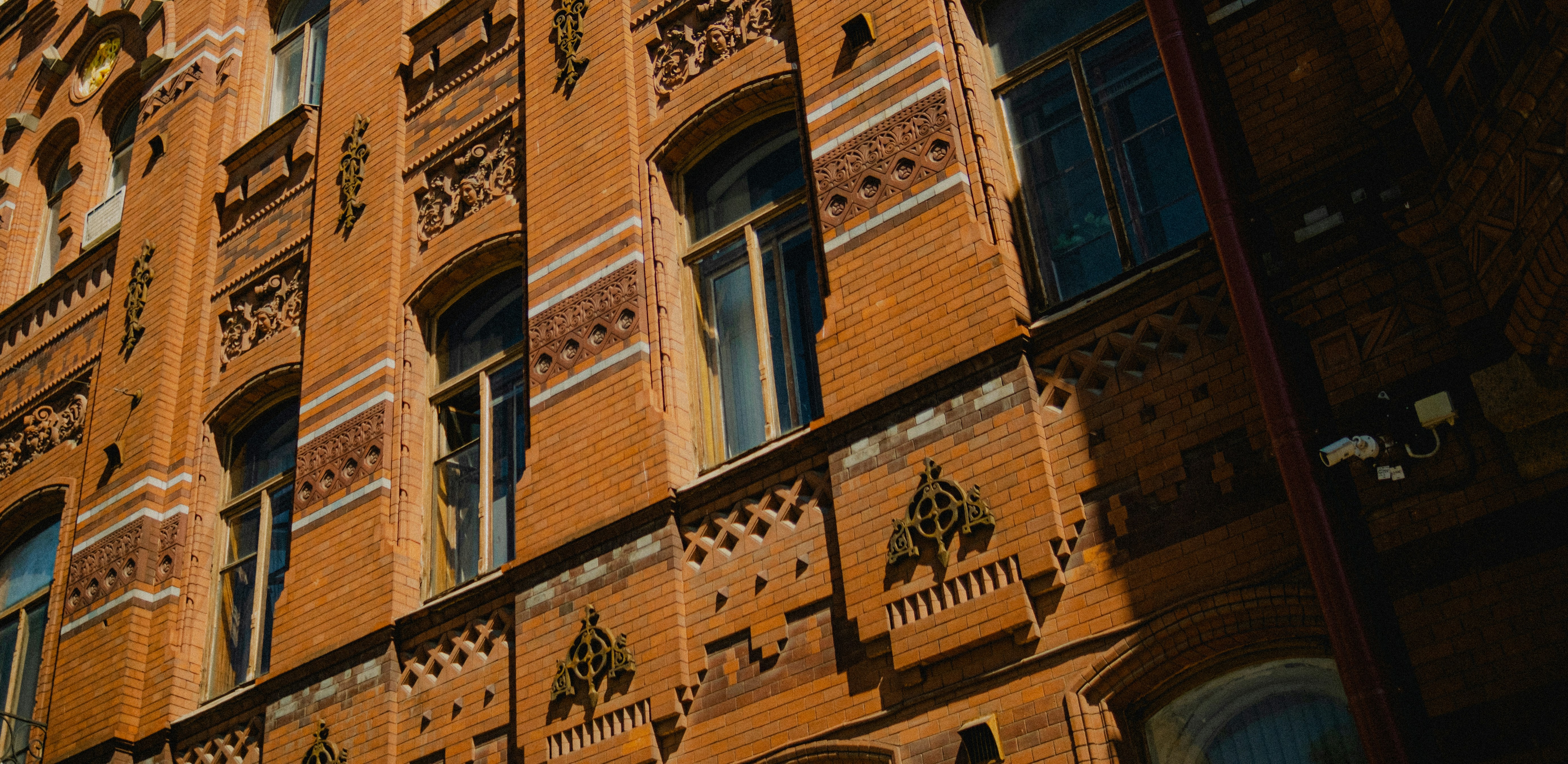 Brickwork Mosaic: Sunlit Facade and Ornate Detailing
