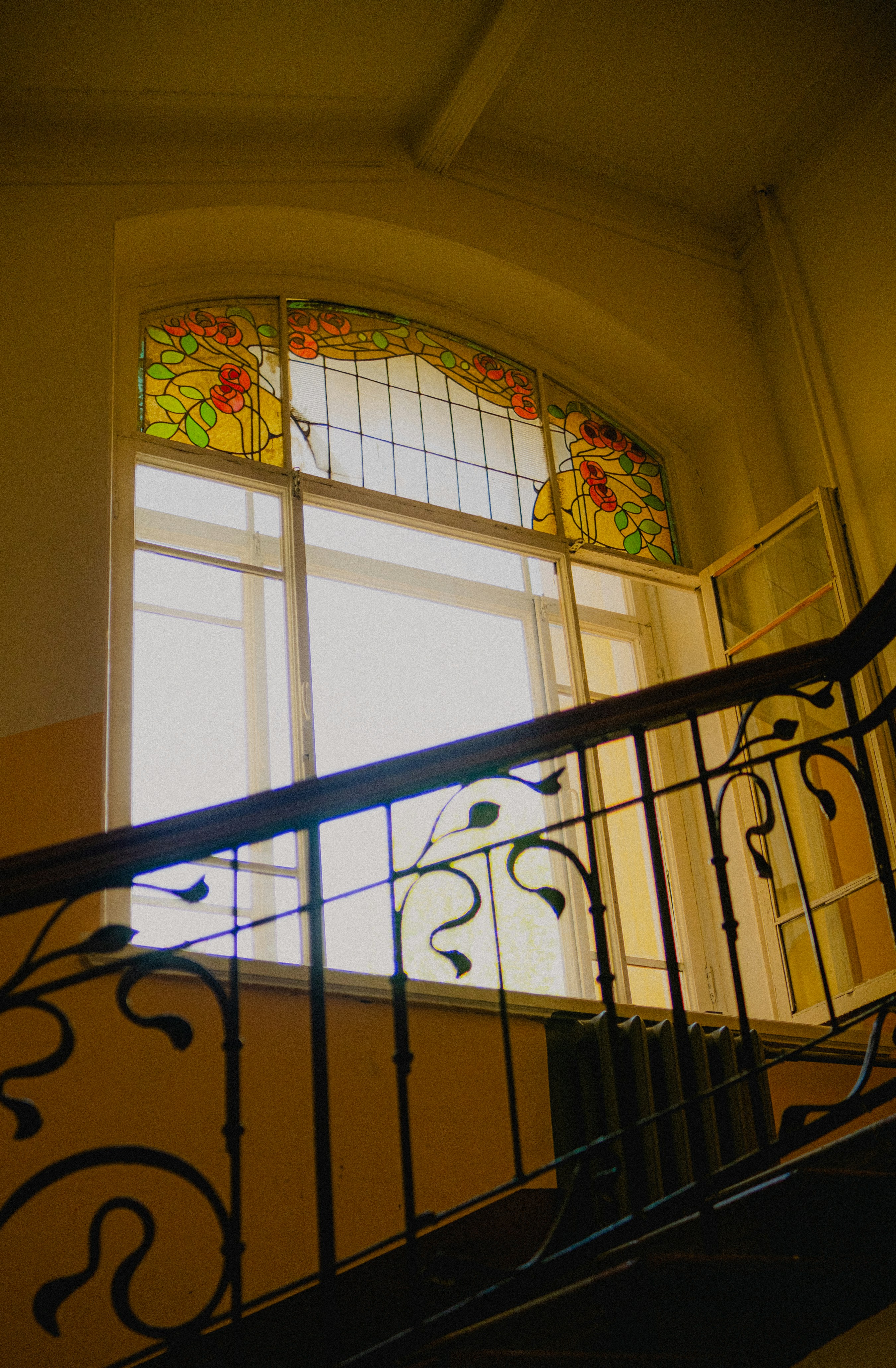 Sunlit Window Arch and Wrought Iron Staircase