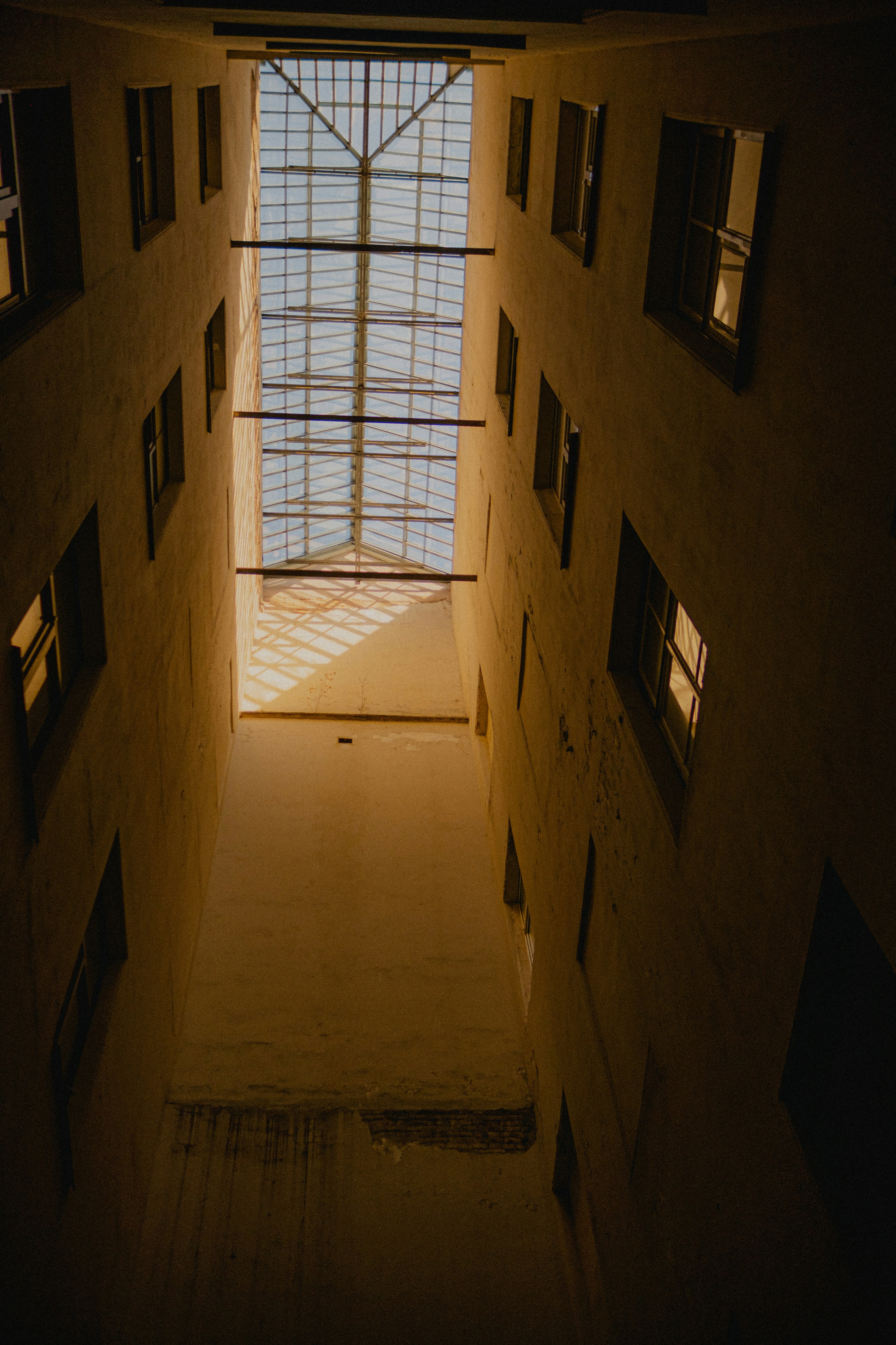 Vertical Atrium: Sunlit Roof Lantern Framed by Narrow Courtyard Walls