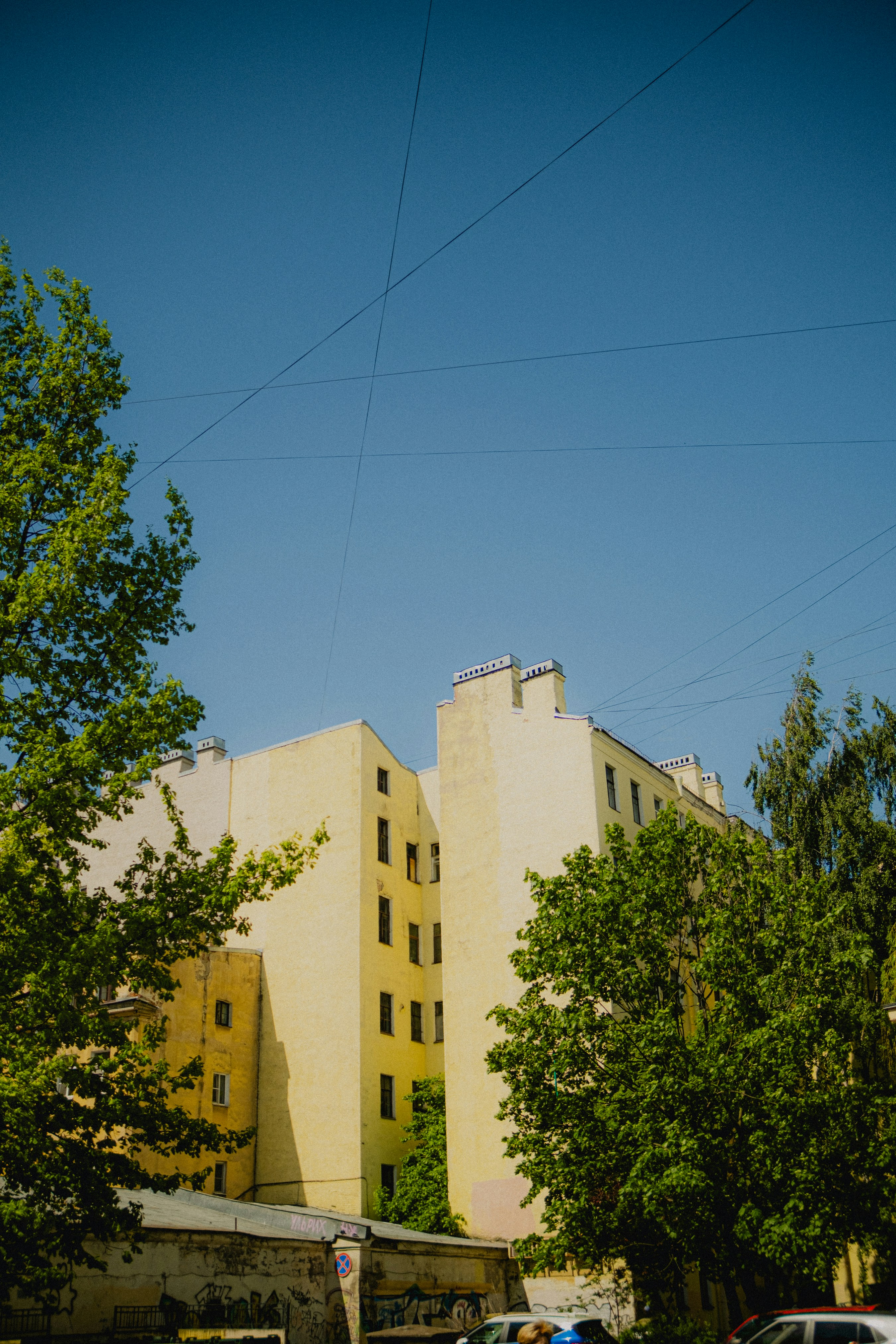 Sunlit Courtyard of a Yellow Apartment Block