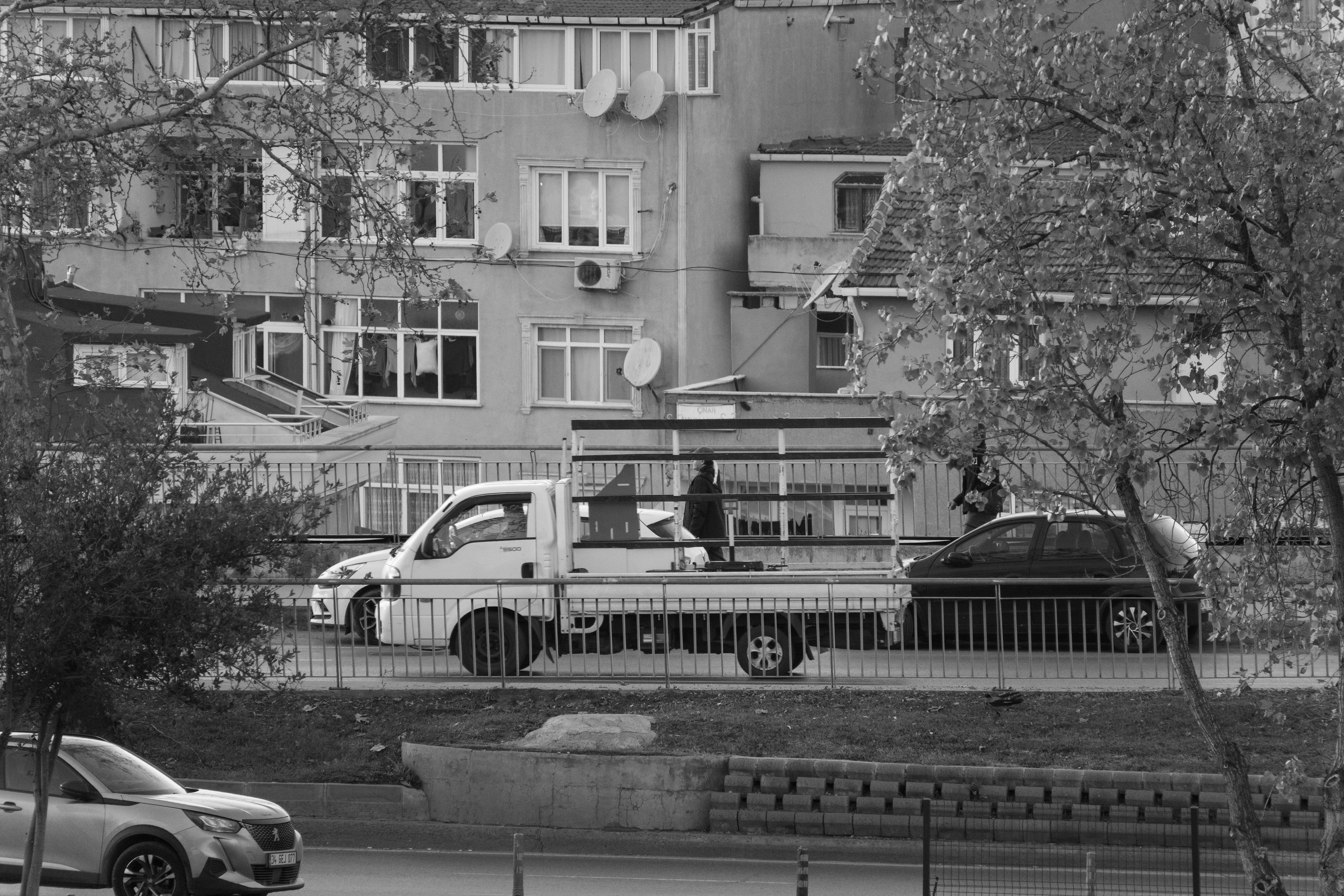 Urban Transit in Soft Focus: A Silhouette by the Fence
