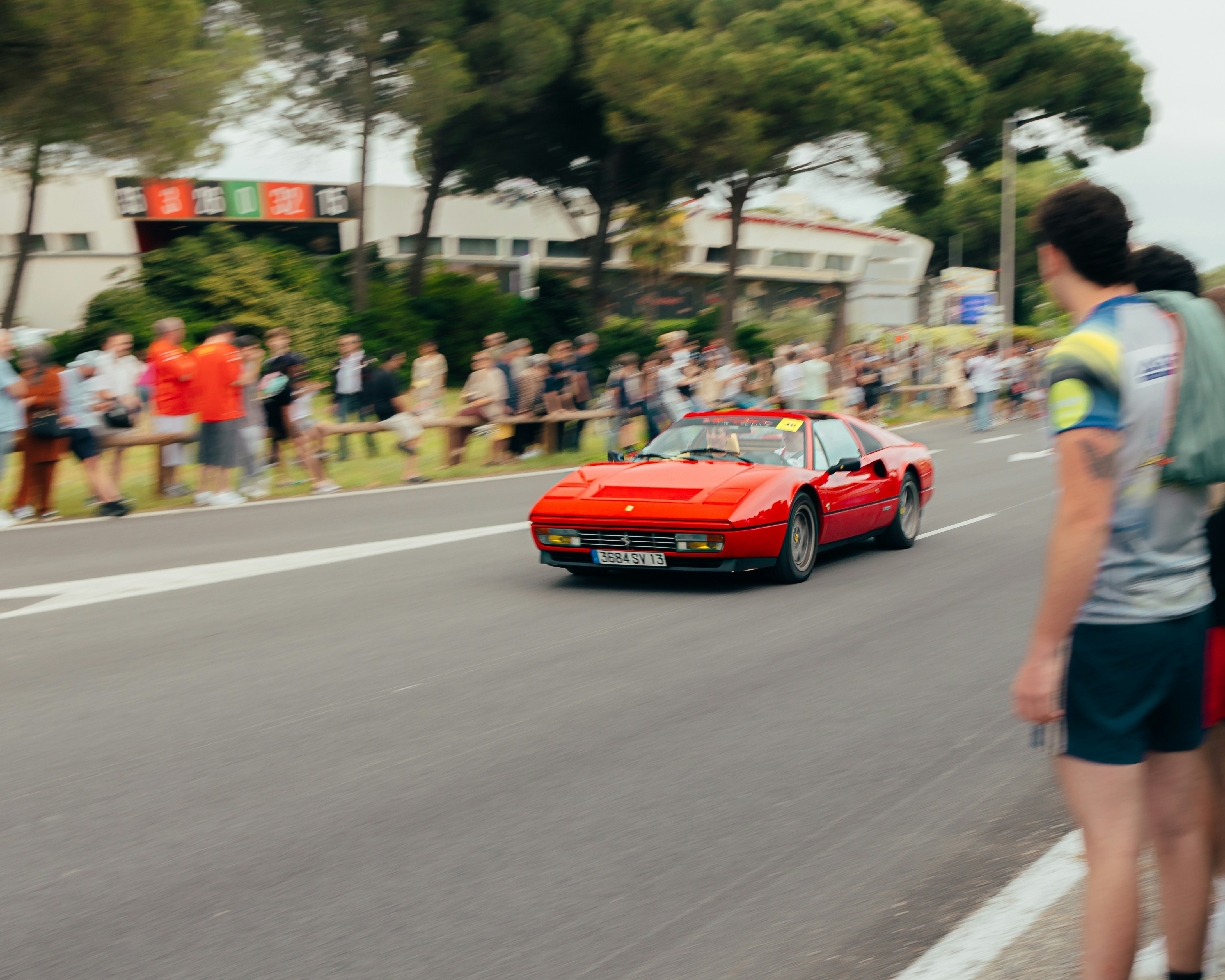 Red Classic in Motion: A Rally of Onlookers