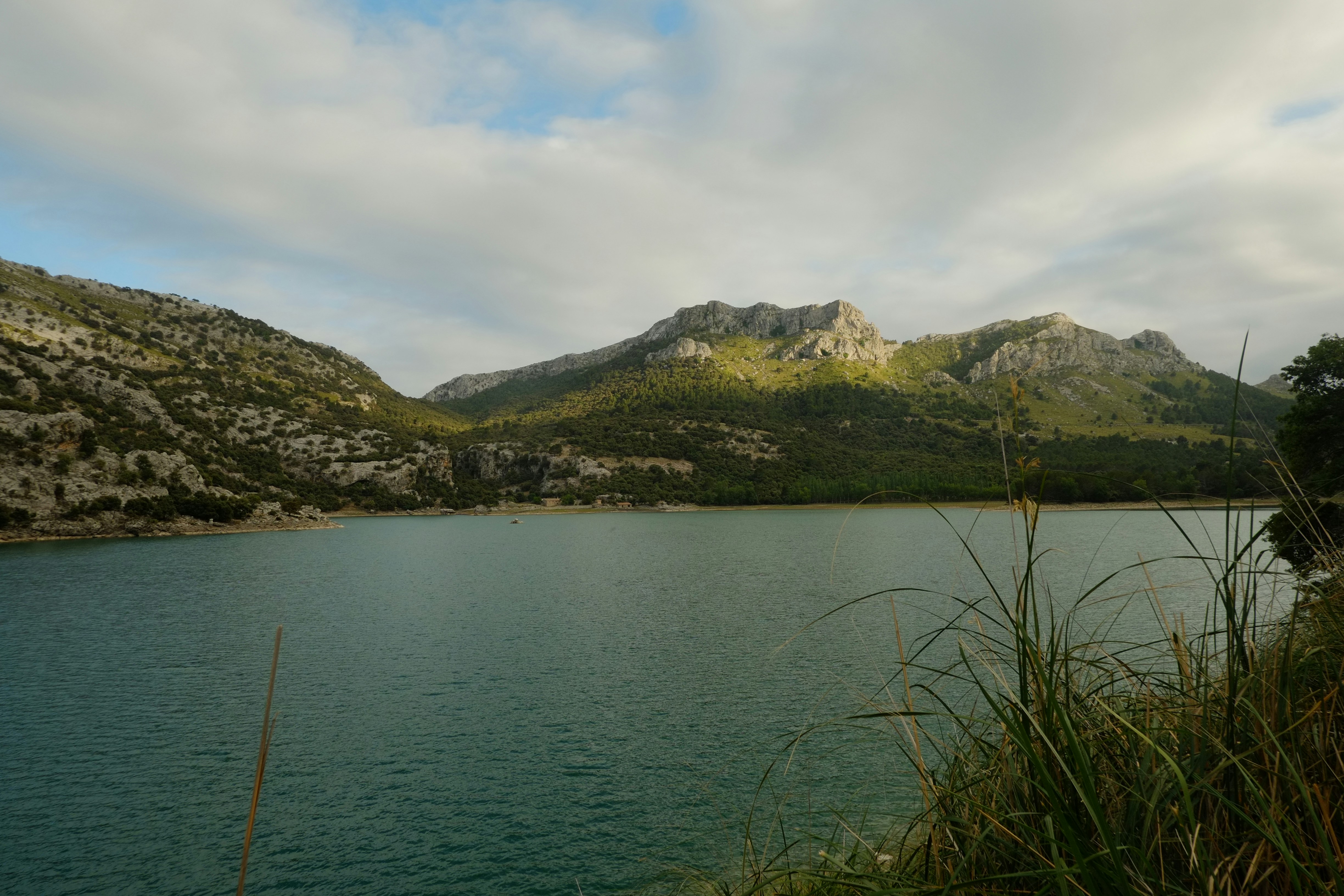 Azure Lake Beneath Rugged Hills at Dusk