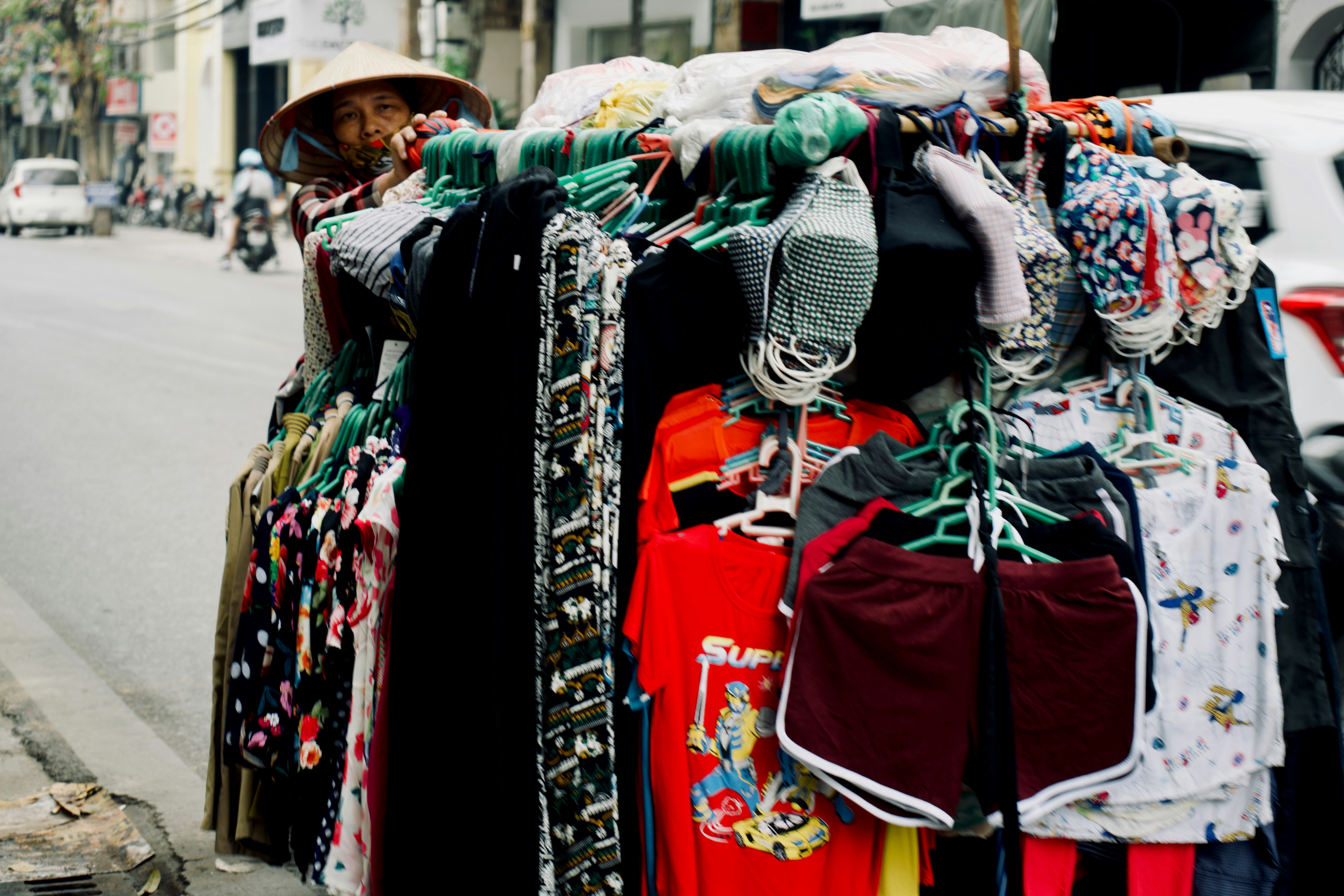 Colorful Garment Rack on a Busy Street
