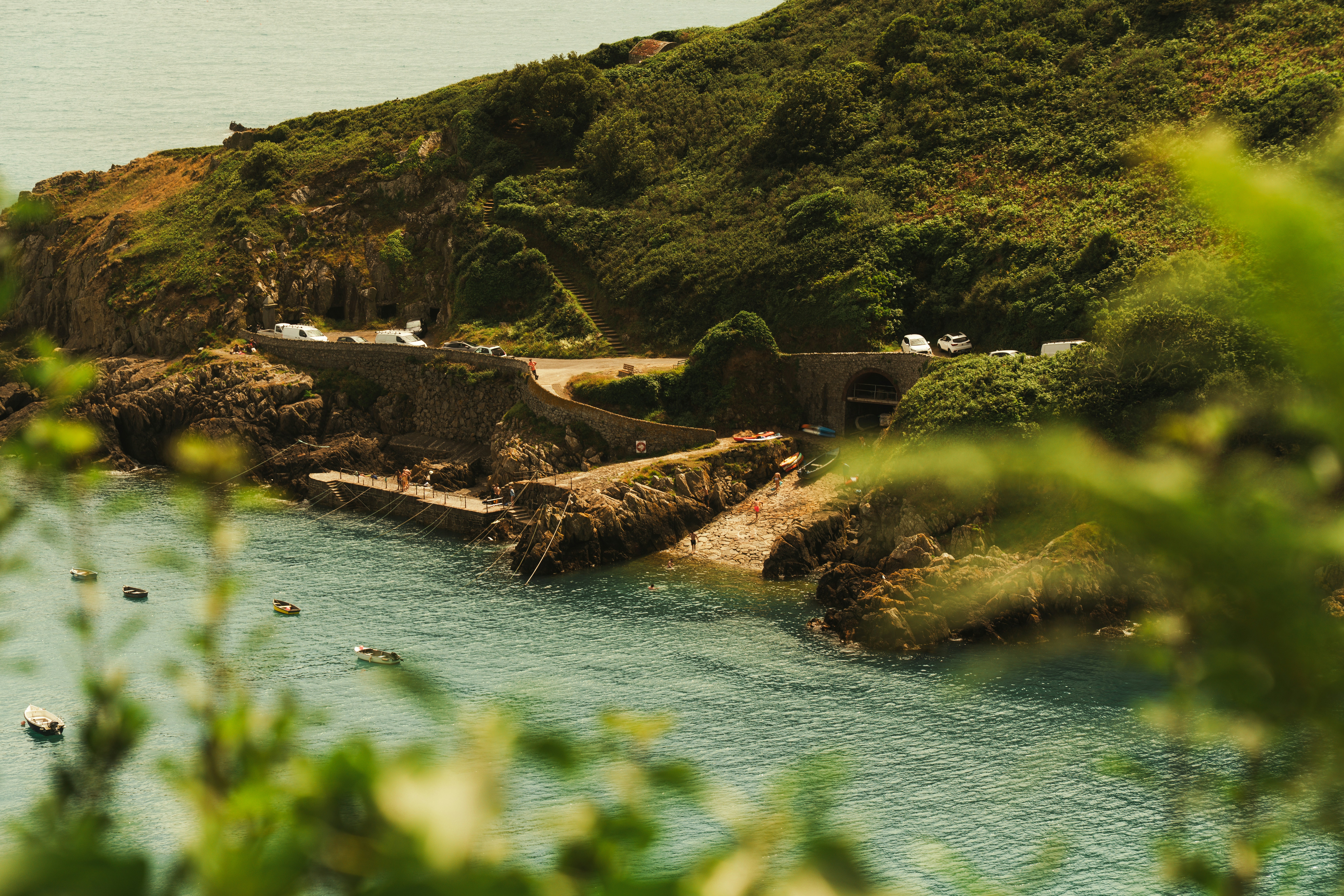 Hidden Cove Under the Arch: Boats, Bridge, and Greenery