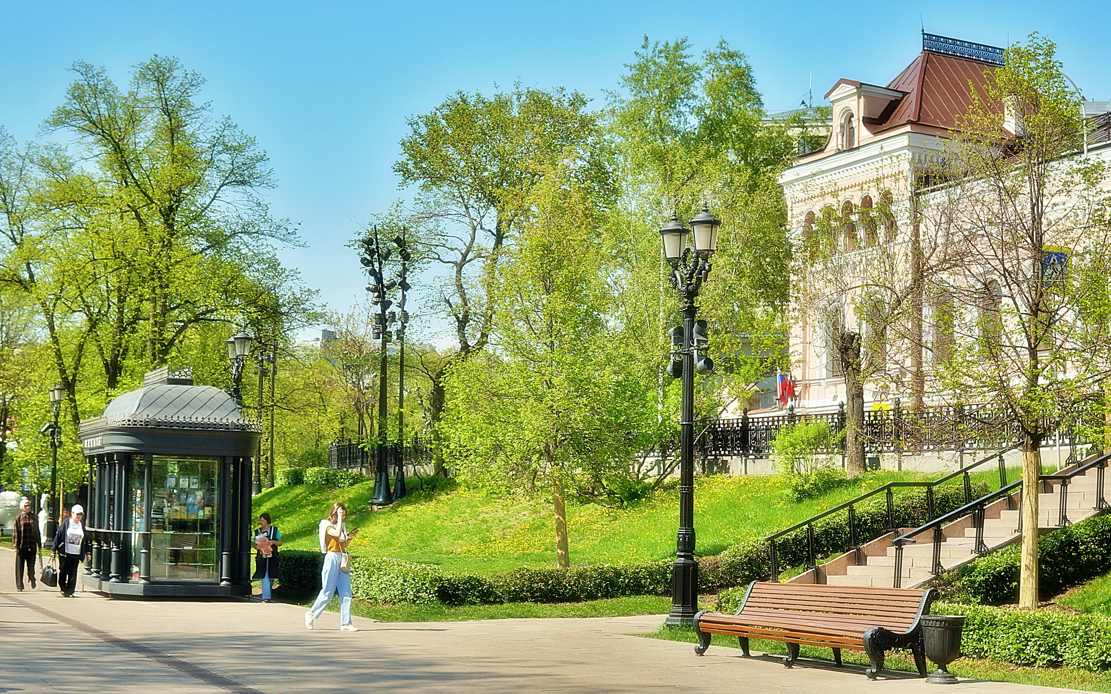 Sunlit Park Terrace: A Classical Building Overlooked by Dappled Spring Trees