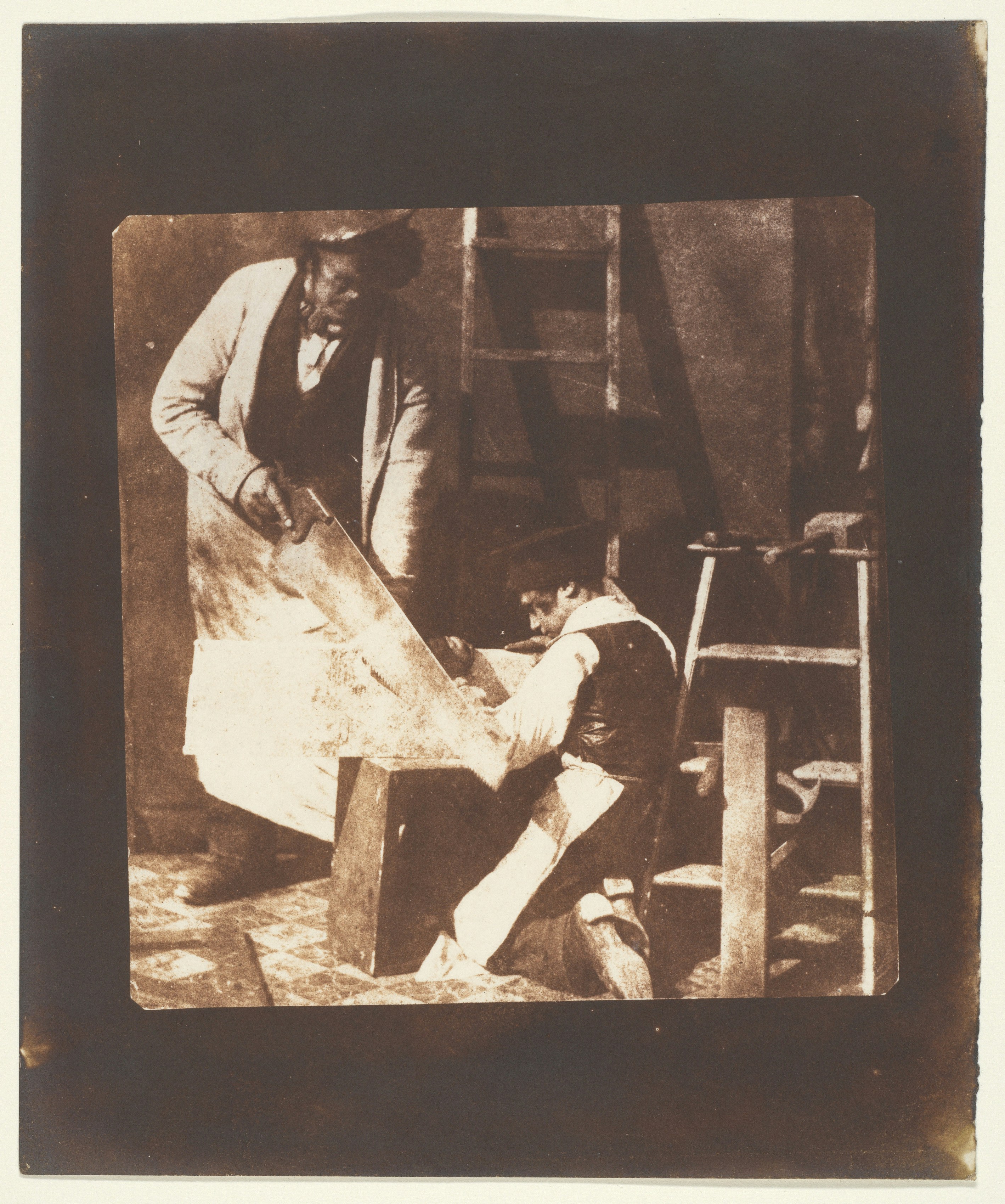 Lifesize Draft: Two Aides at a Woodworking Bench in a Vintage Studio